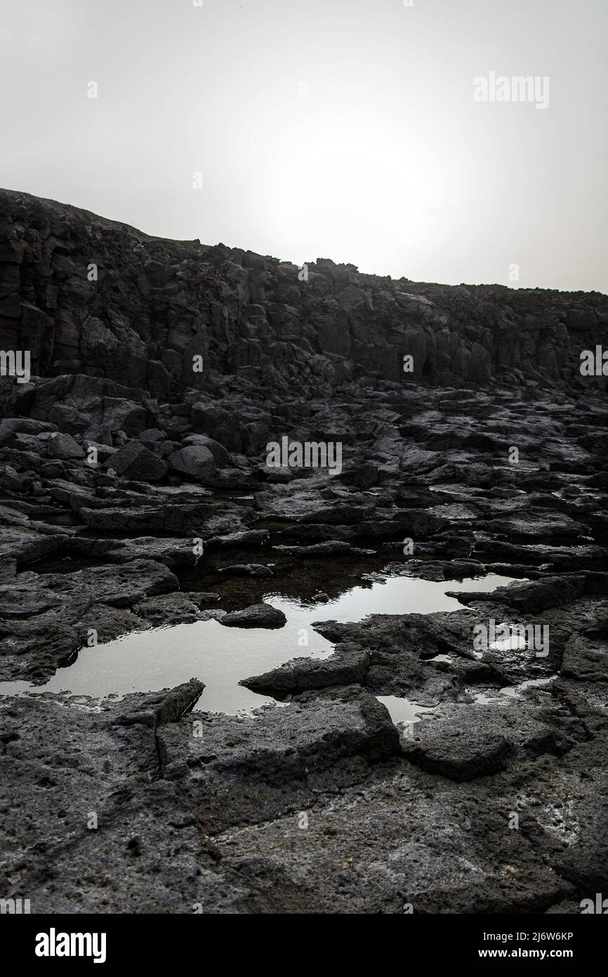 Volcanic landscape. Cooled lava is black rocky texture Stock Photo - Alamy