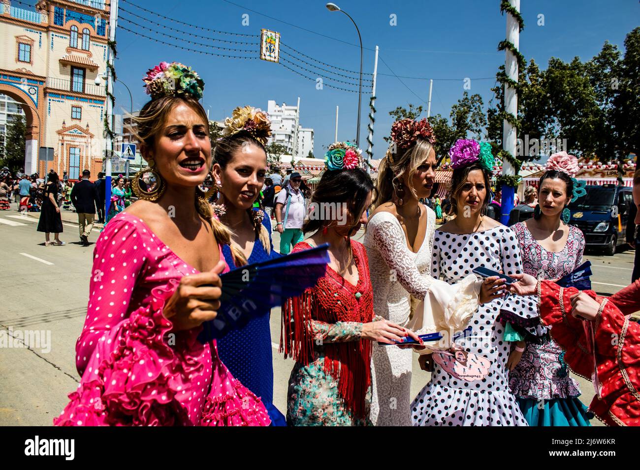 Seville, Spain - May 01, 2022 Sevillians dressed in traditional ...