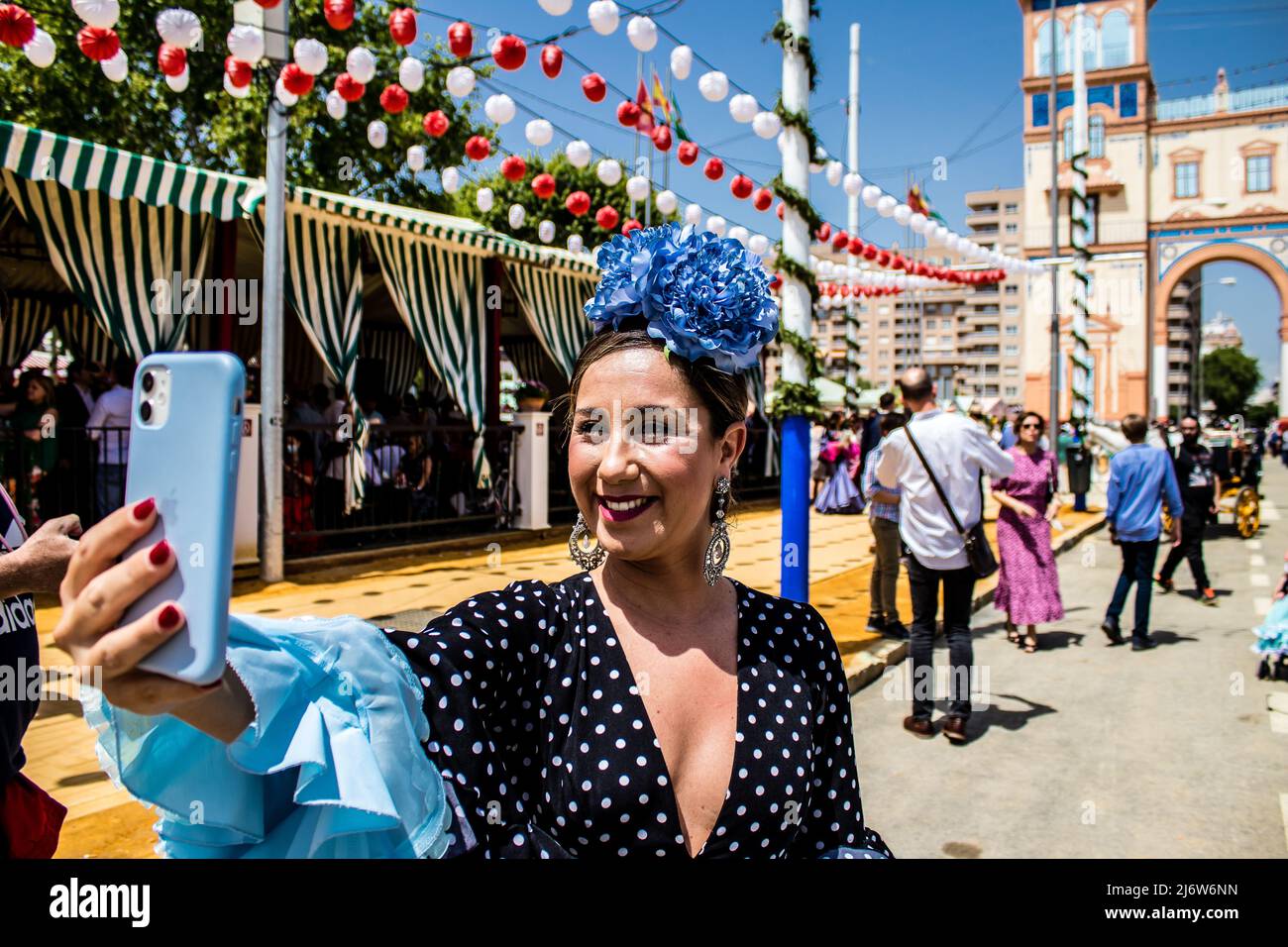 Seville, Spain - May 01, 2022 Sevillians dressed in traditional ...
