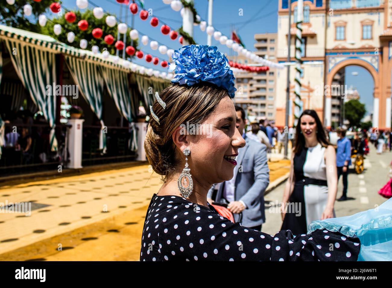 Seville, Spain - May 01, 2022 Sevillians dressed in traditional ...
