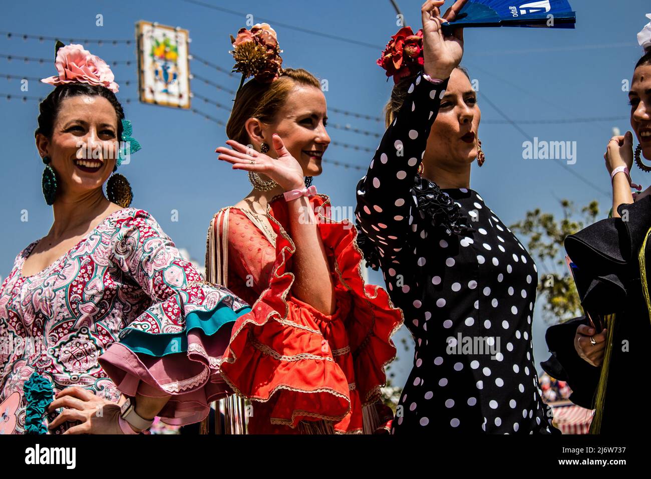 Seville, Spain - May 01, 2022 Sevillians dressed in traditional ...