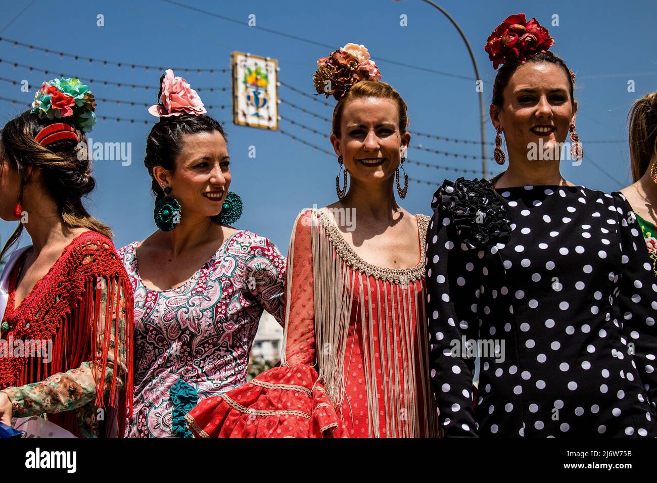Seville, Spain - May 01, 2022 Sevillians dressed in traditional ...