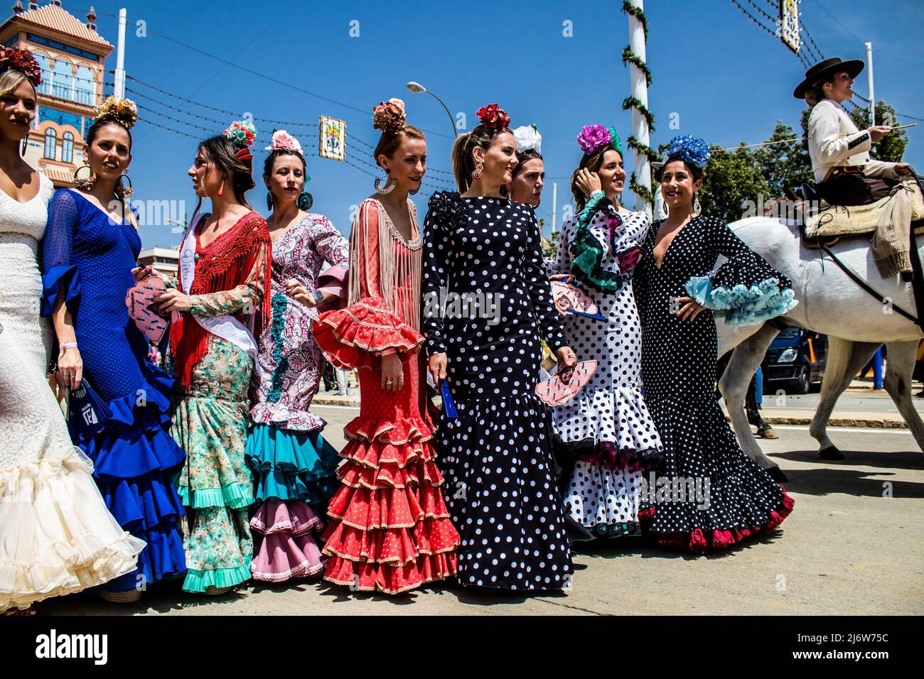 Seville, Spain - May 01, 2022 Sevillians dressed in traditional ...
