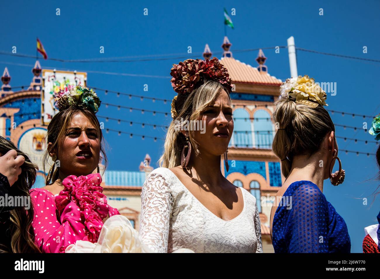 Seville, Spain - May 01, 2022 Sevillians dressed in traditional ...