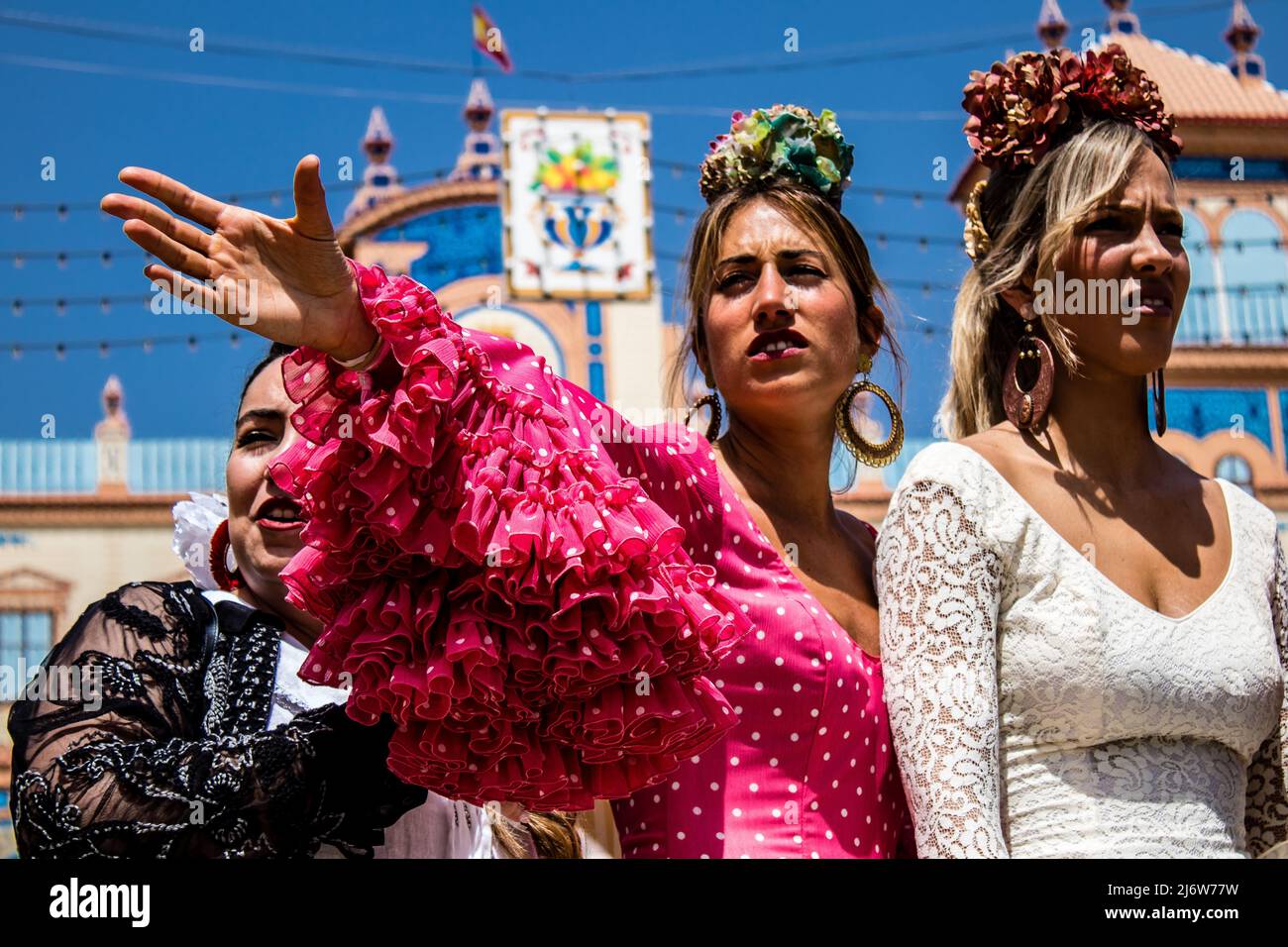 Seville, Spain - May 01, 2022 Sevillians dressed in traditional ...