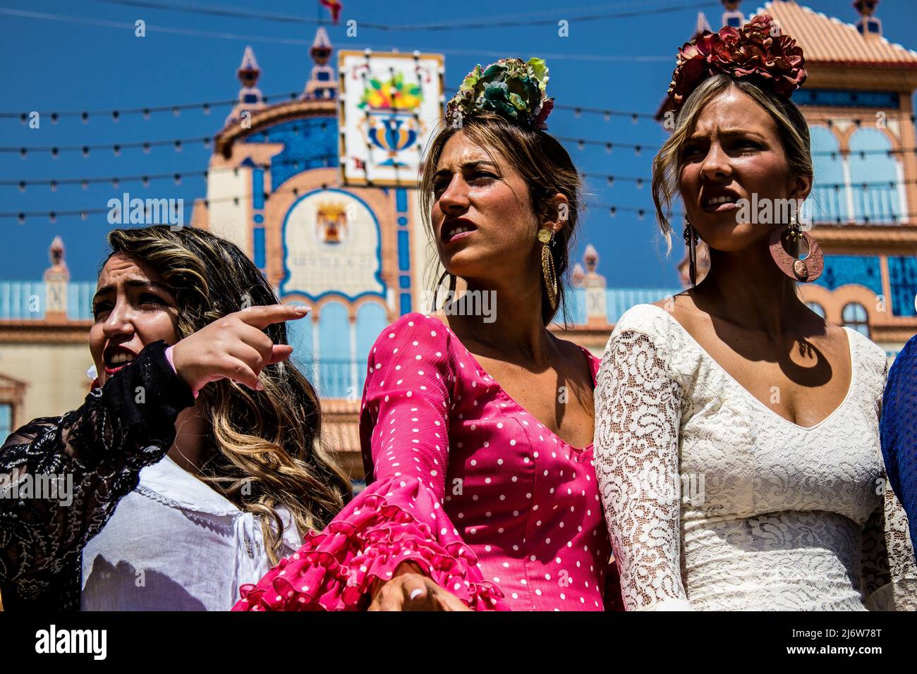 Seville, Spain - May 01, 2022 Sevillians dressed in traditional ...