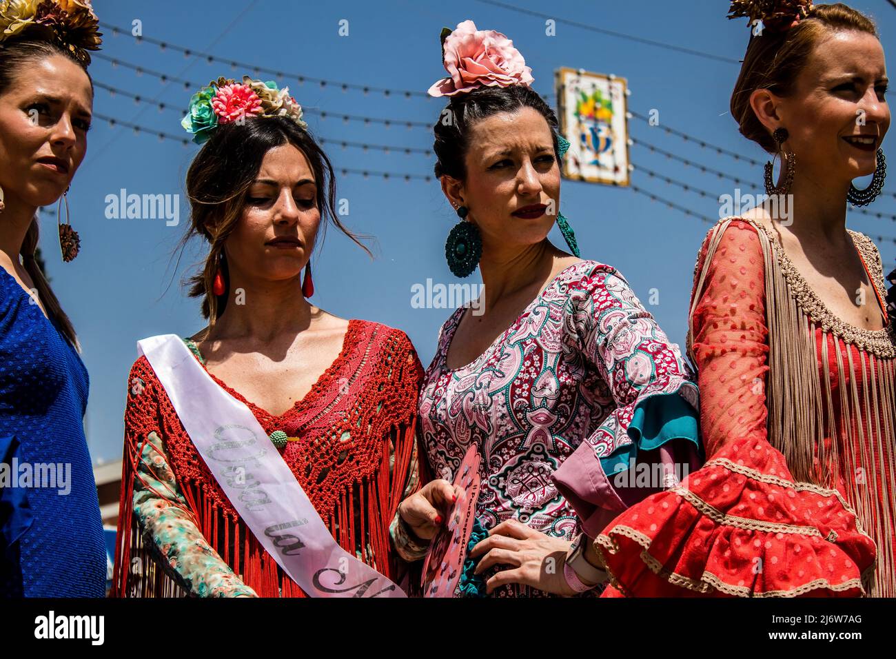 Seville, Spain - May 01, 2022 Sevillians dressed in traditional ...