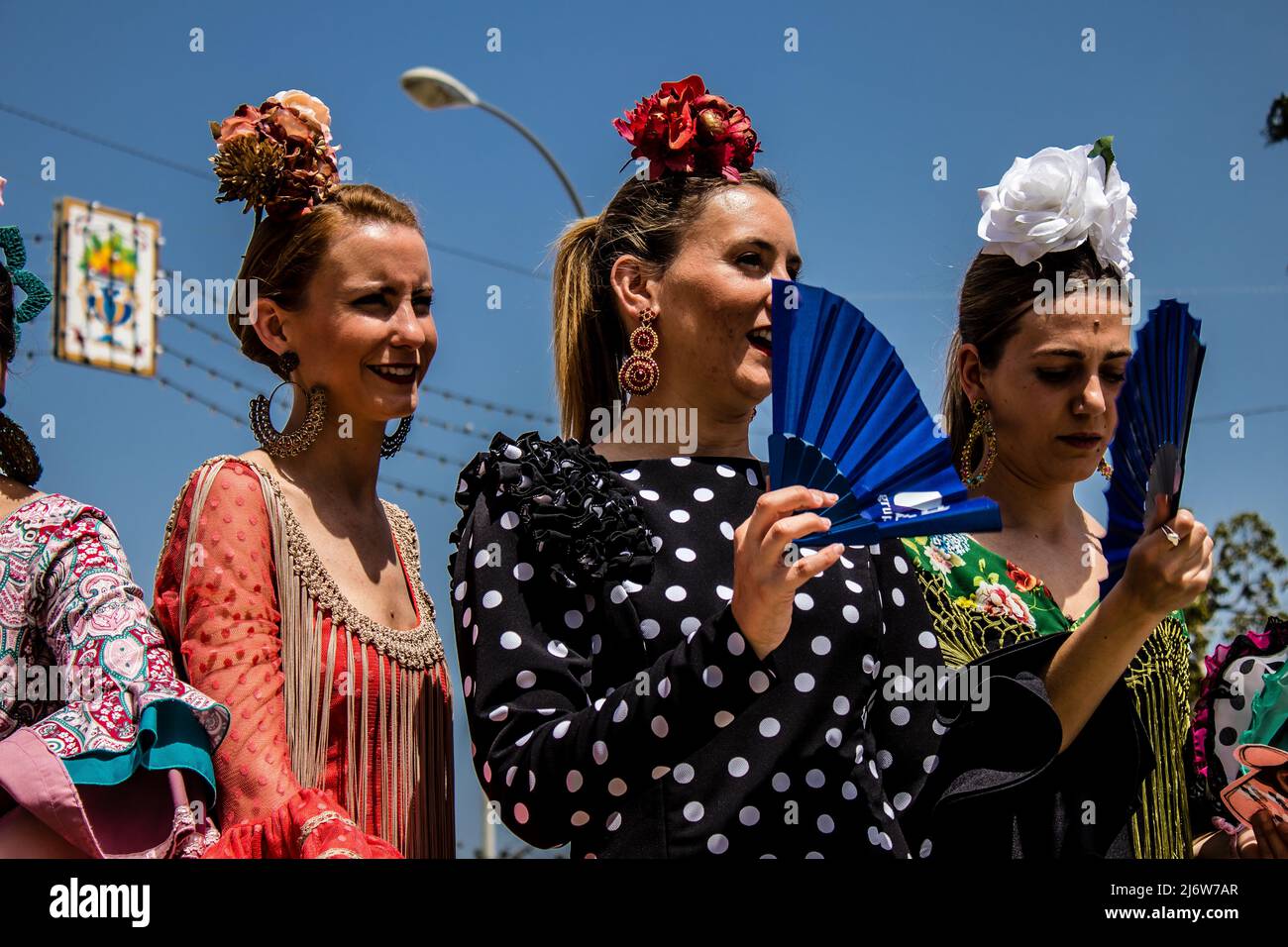 Seville, Spain - May 01, 2022 Sevillians dressed in traditional ...