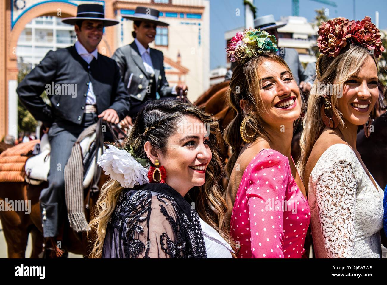 Seville, Spain - May 01, 2022 Sevillians dressed in traditional ...