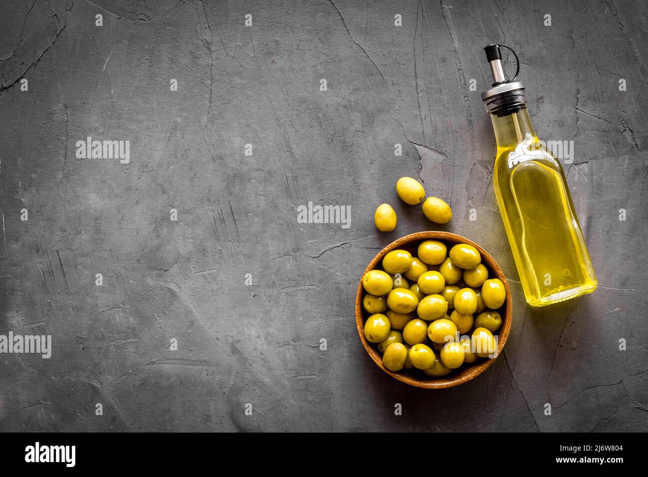 Olive oil in bottle with green olives. Cooking oil background Stock ...