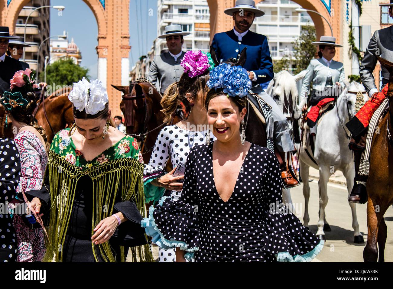 Seville, Spain - May 01, 2022 Sevillians dressed in traditional ...