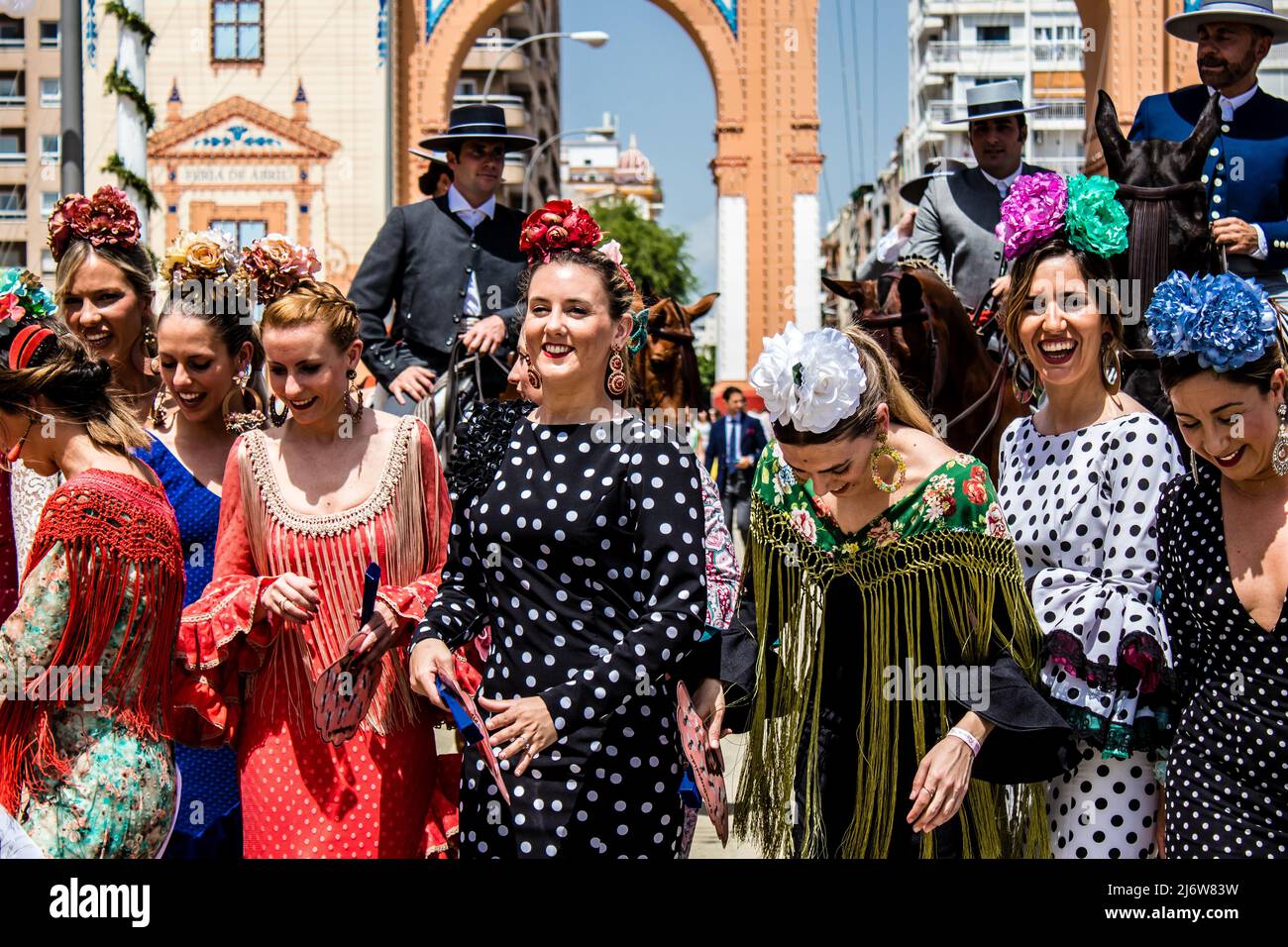 Seville, Spain - May 01, 2022 Sevillians dressed in traditional ...