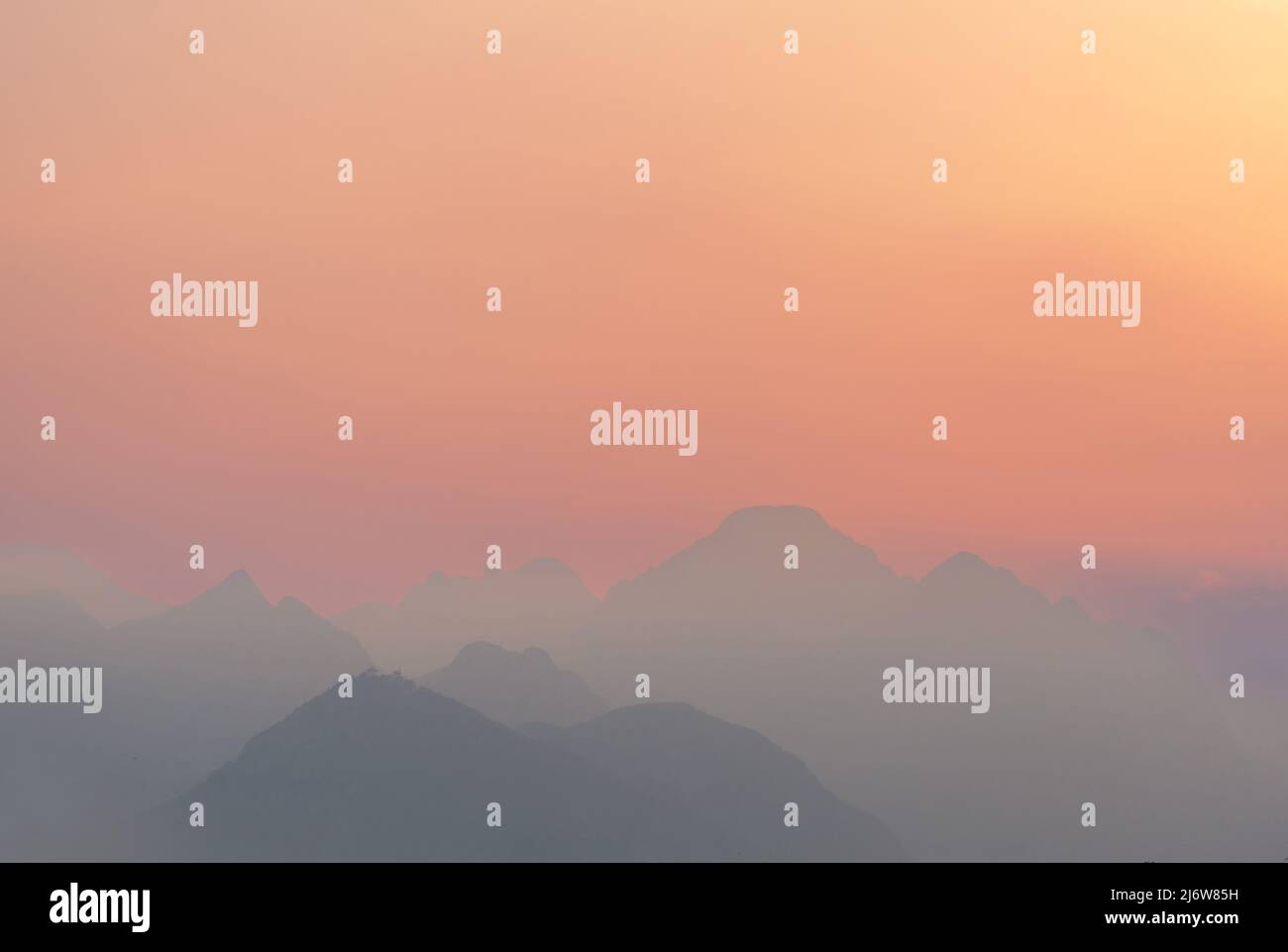 bright sunset or sunrise sky with misty mountains Stock Photo - Alamy