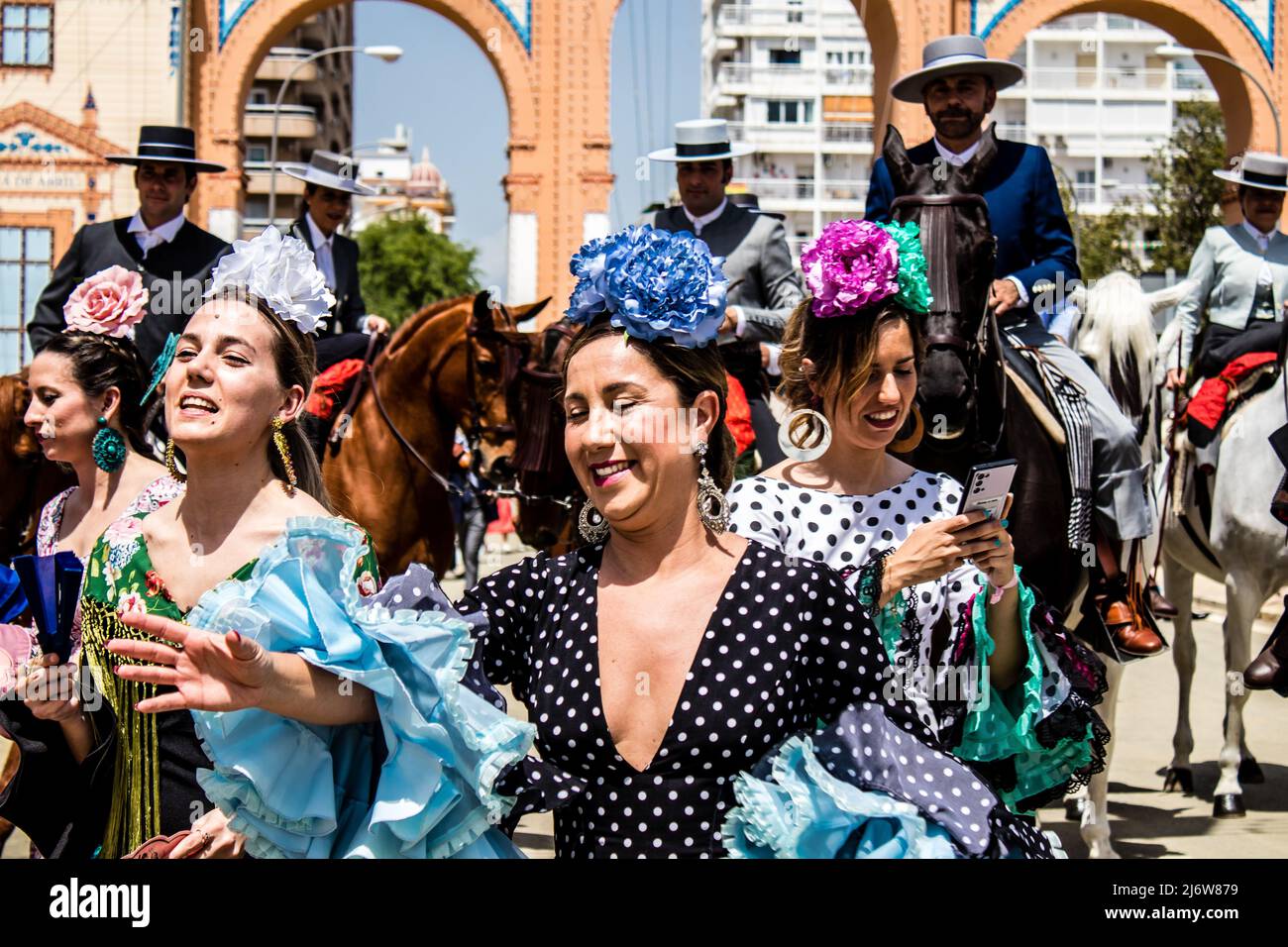 Seville, Spain - May 01, 2022 Sevillians dressed in traditional ...