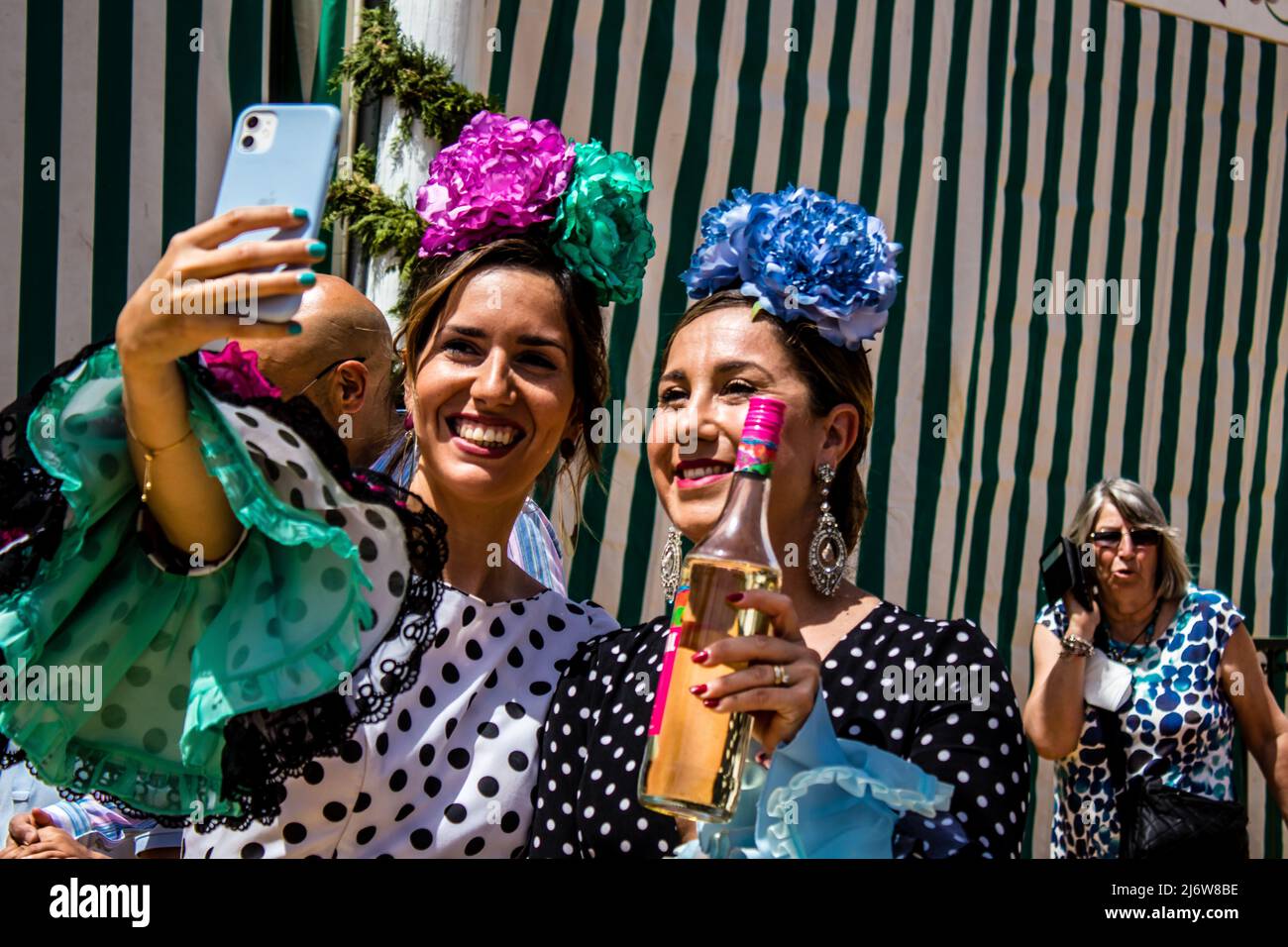 Seville, Spain - May 01, 2022 Sevillians dressed in traditional ...