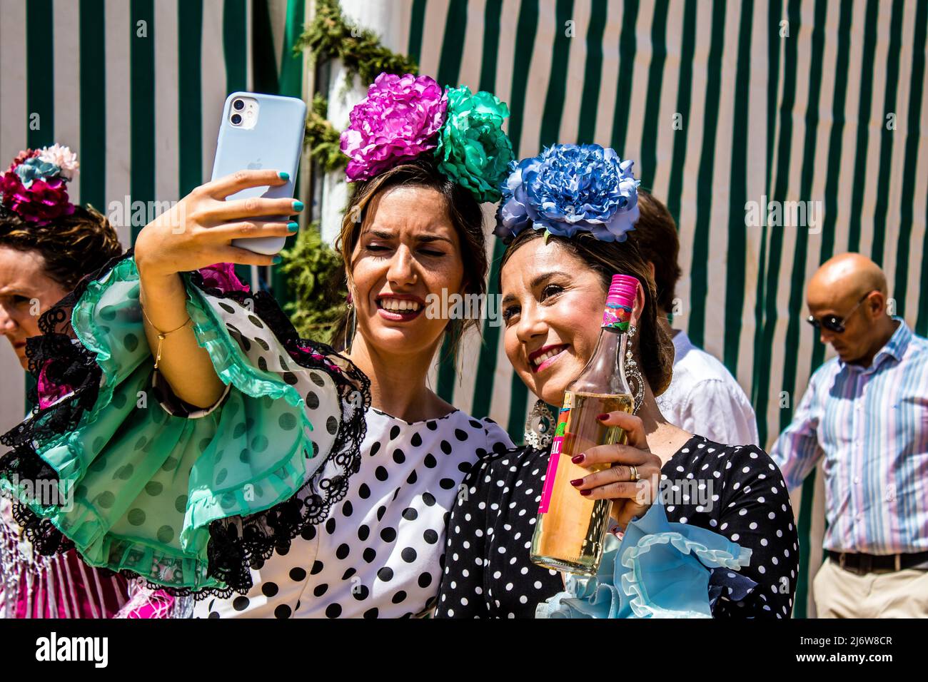 Seville, Spain - May 01, 2022 Sevillians dressed in traditional ...