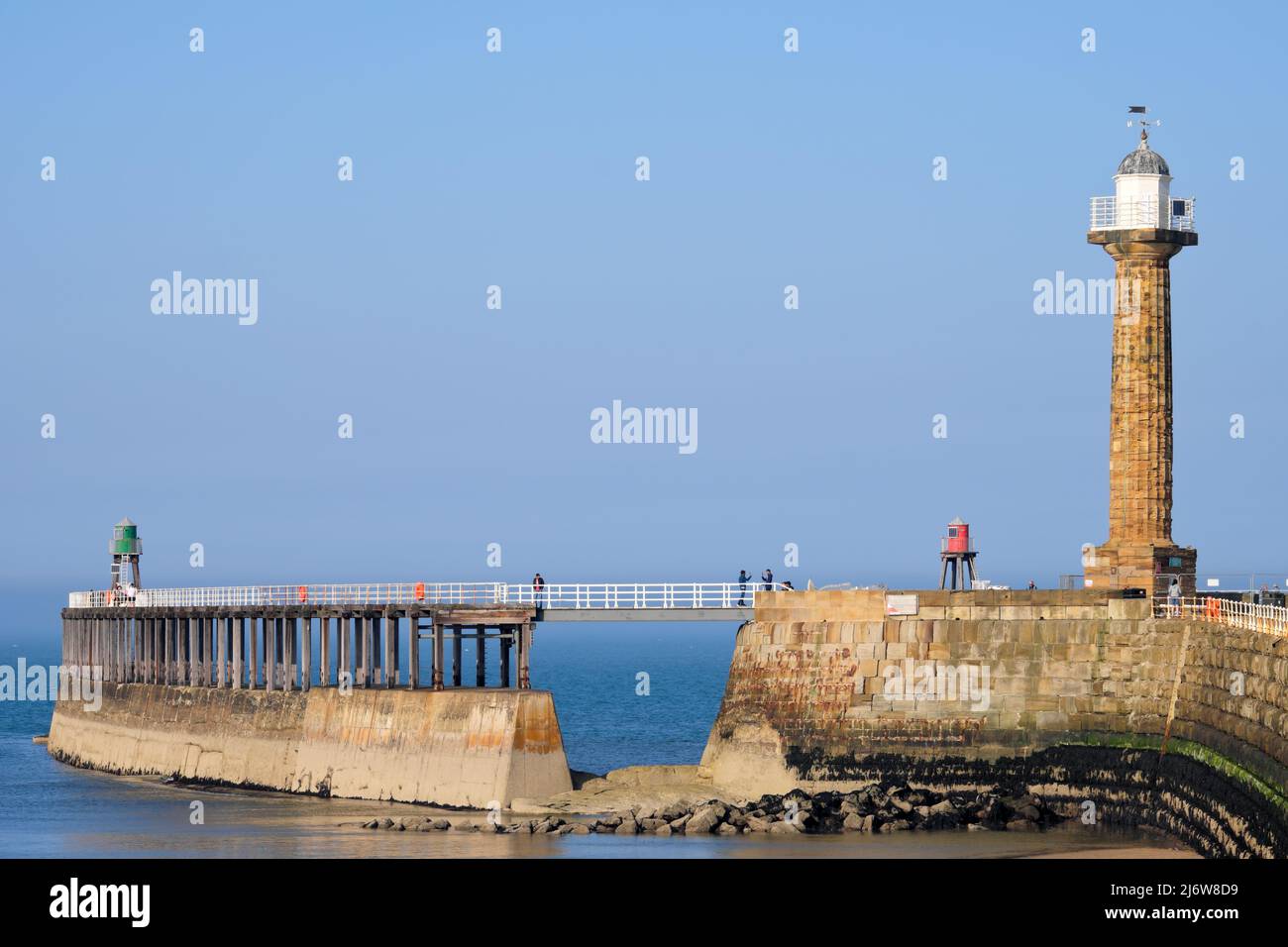The boardwalk & concrete pillars to the lighthouse on Whitby's outer ...