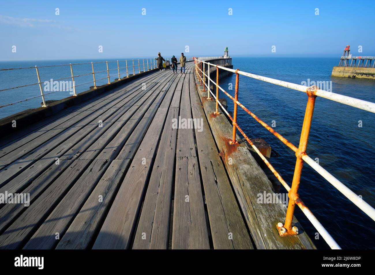 The boardwalk to the lighthouse on Whitby's outer harbour in Whitby ...