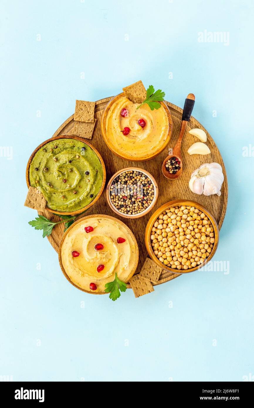 Hummus with snacks set - various types of hummus in bowls Stock Photo ...