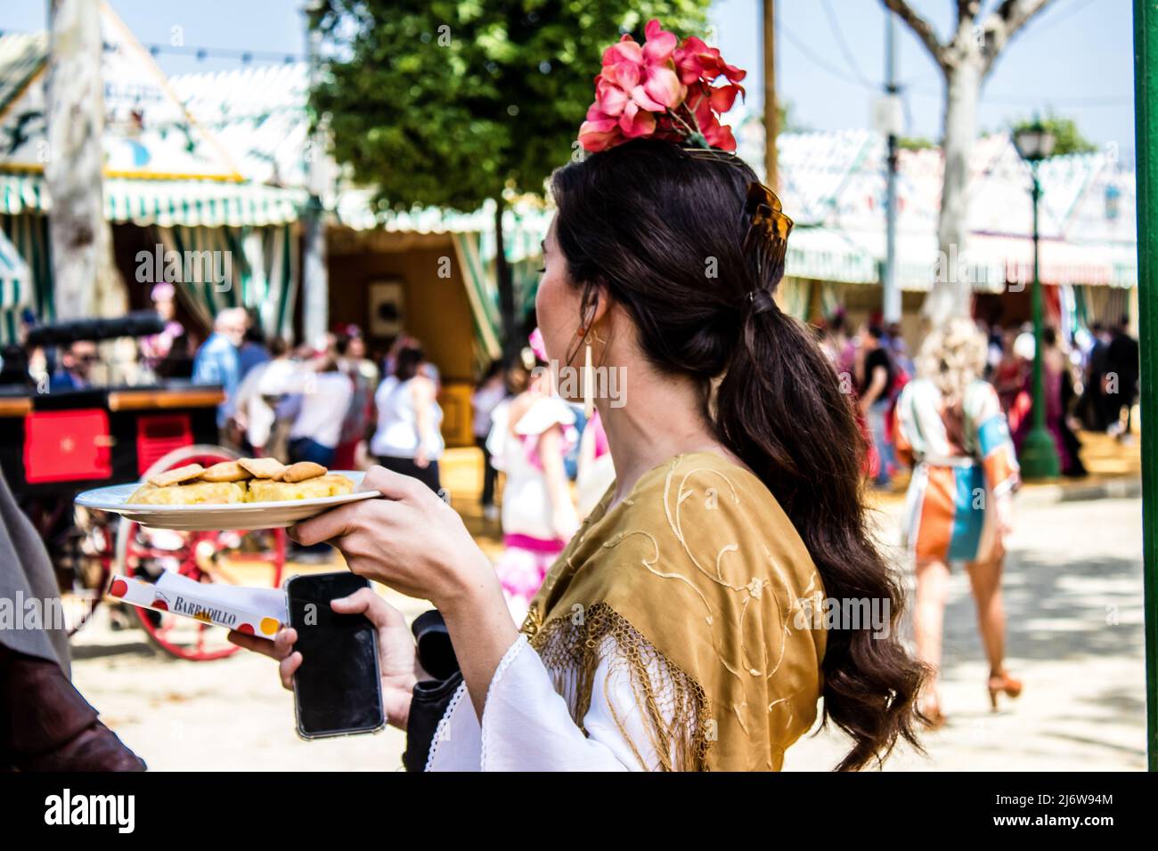 Seville, Spain - May 01, 2022 Sevillians dressed in traditional ...