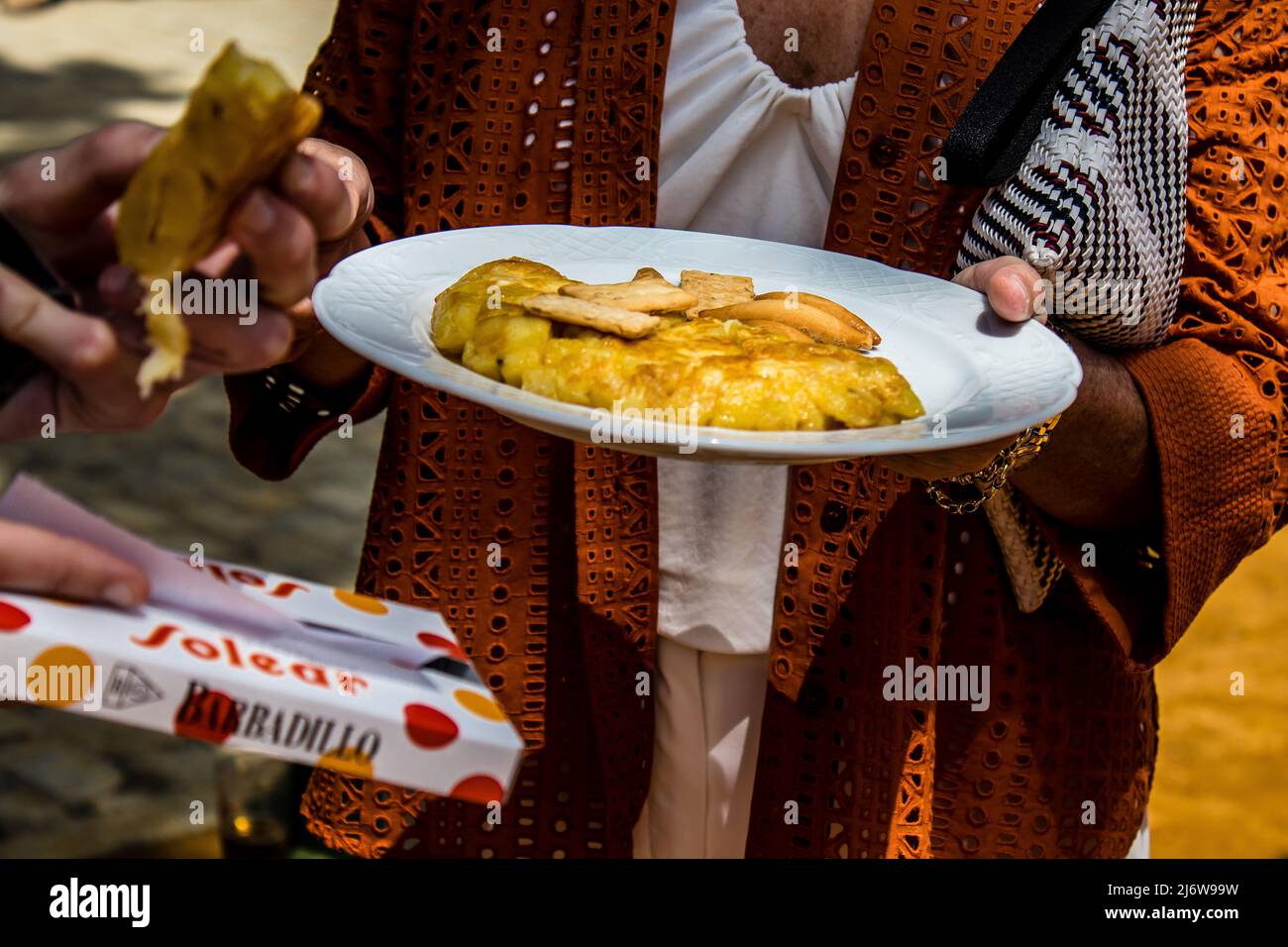 Seville, Spain - May 01, 2022 Sevillians dressed in traditional ...