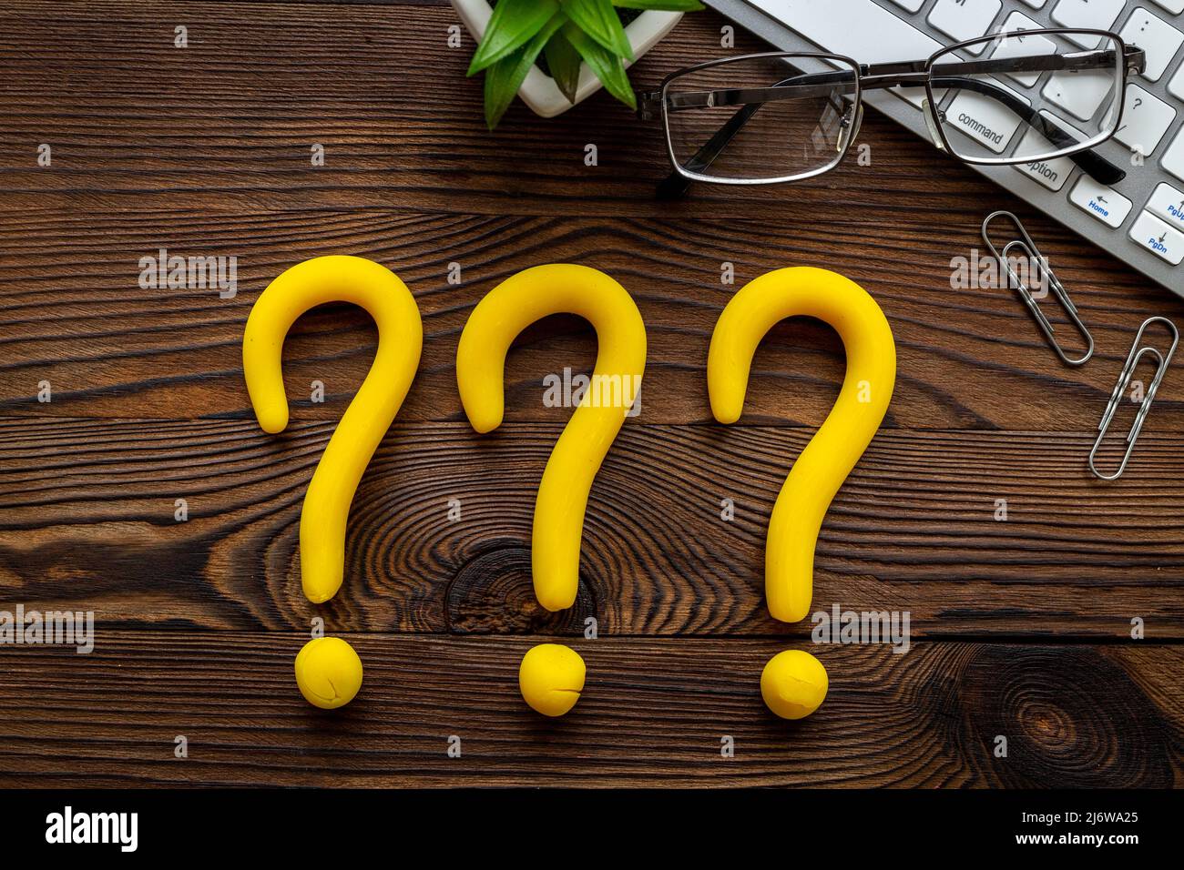 Question mark signs on office table. Customer support servise or FAQ ...