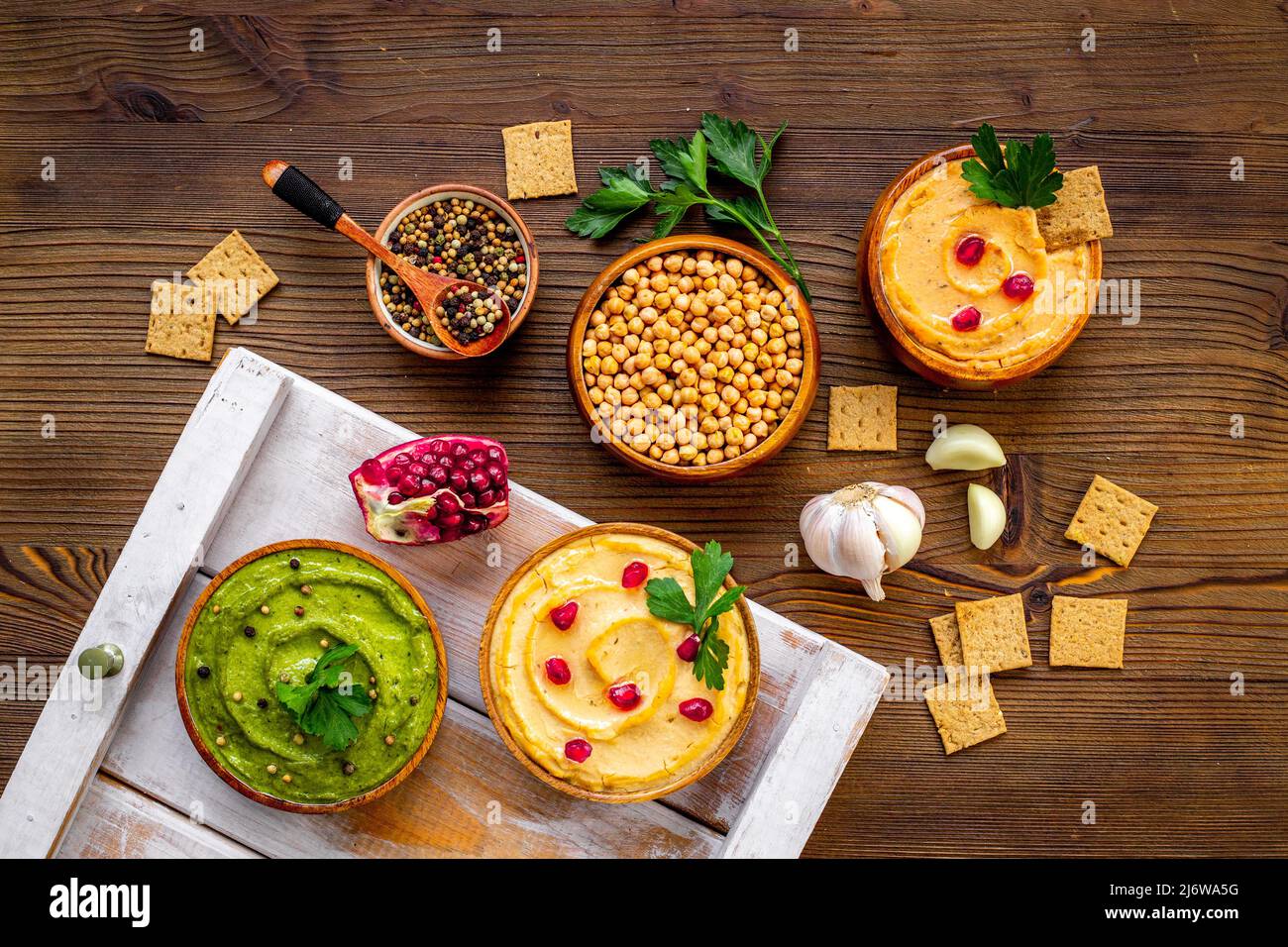Flatlay of different types of colorful hummus in bowls. Vegan food ...