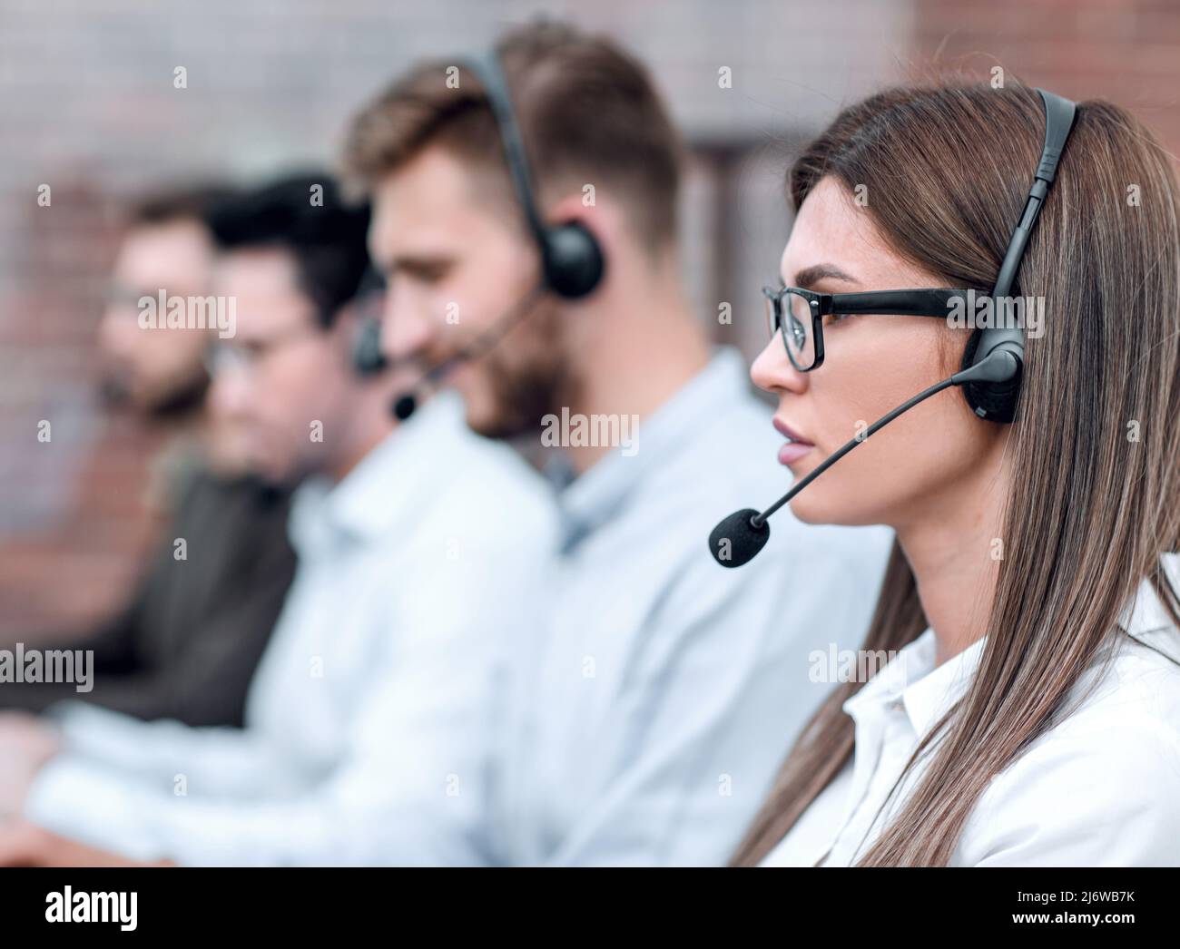 side view.the call center operator and her colleagues work in the ...