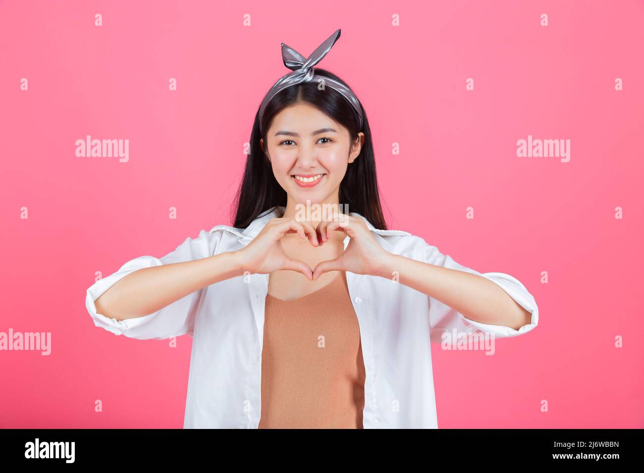 Positive asian woman showing heart hi-res stock photography and images ...