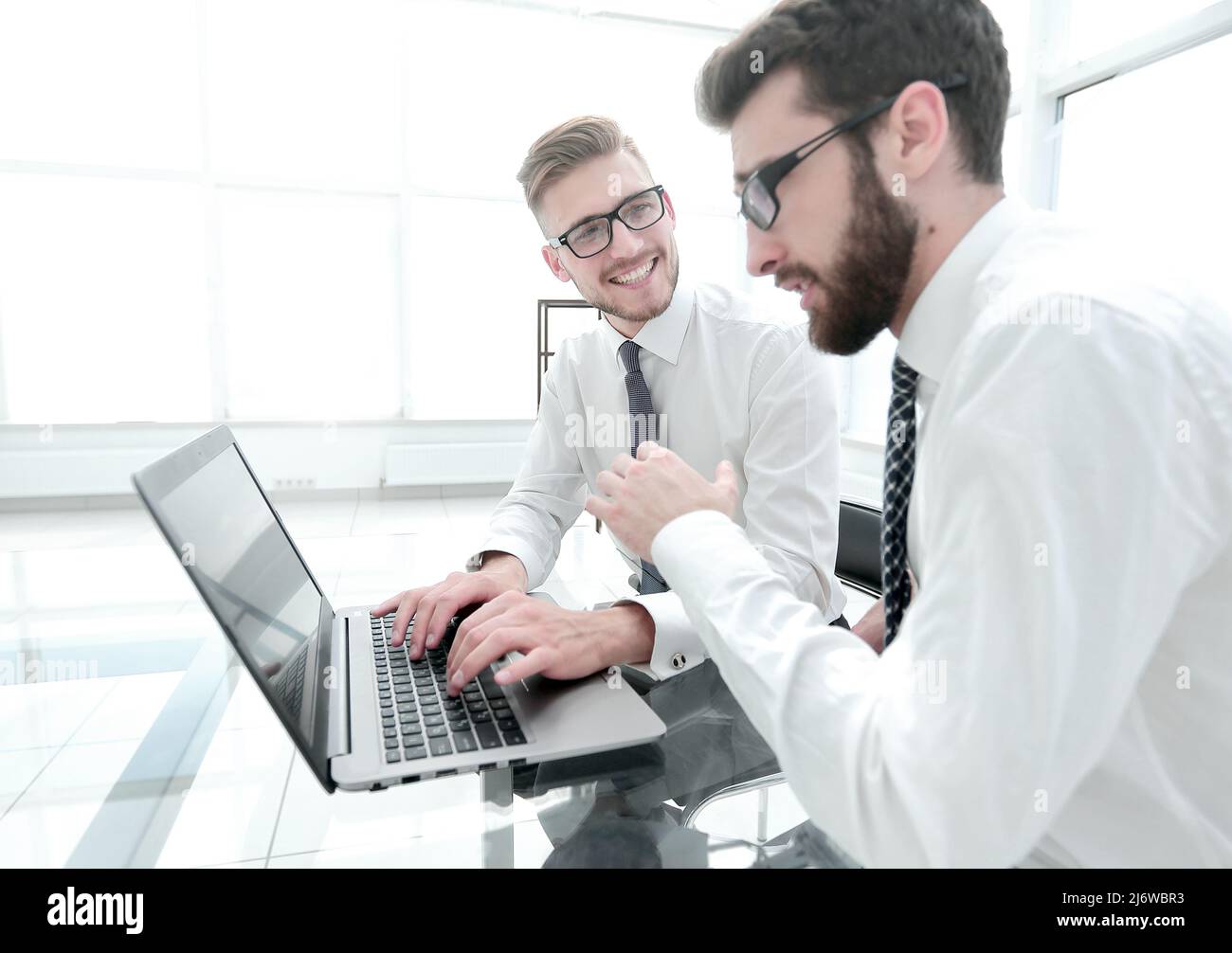 smiling employees at the Desk in the office Stock Photo - Alamy