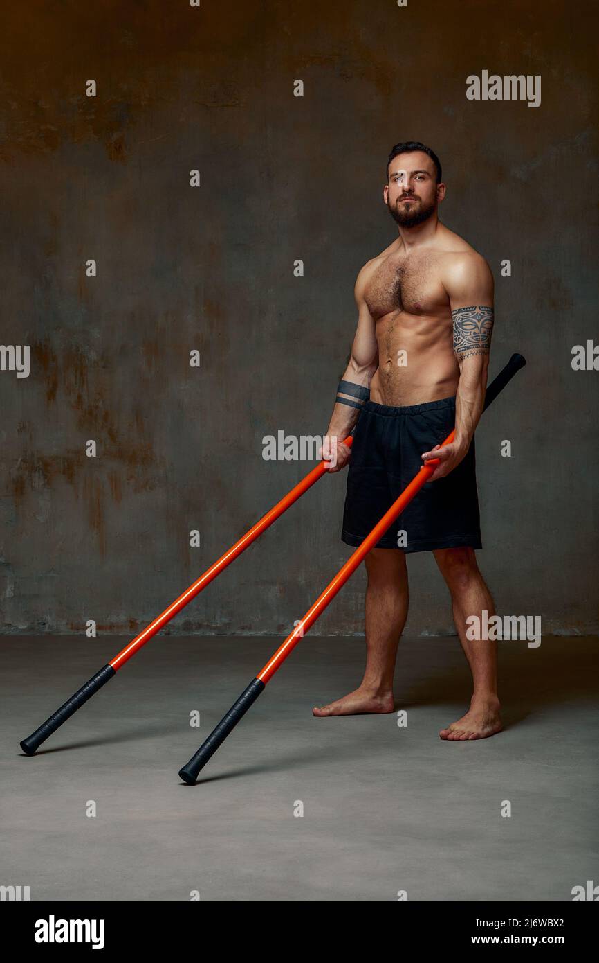 athlete men with stick training karate using sports tool in studio on ...