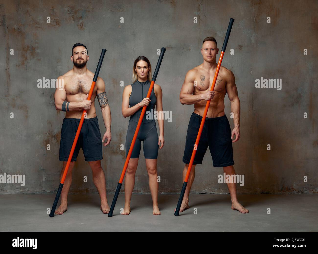 Three martial arts masters, karate, taekwondo practice. Concrete gray ...