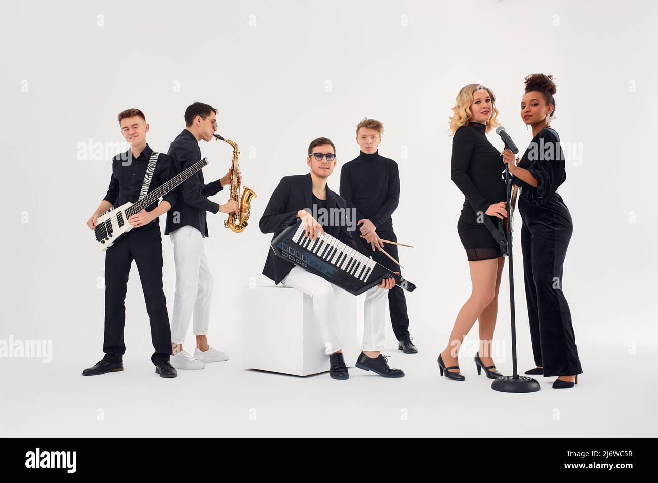 Portrait of diverse group of young people musical band playing with ...