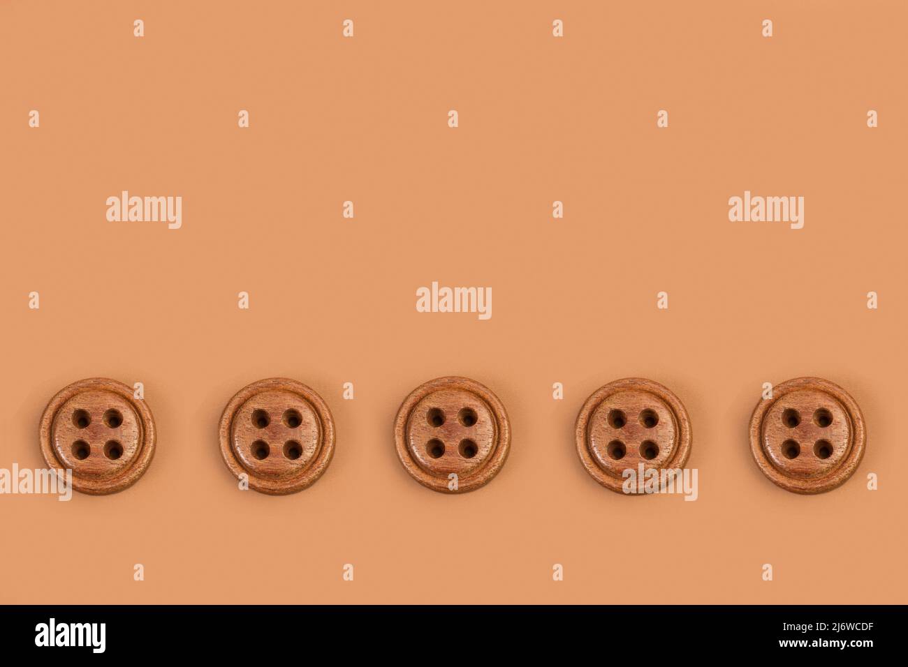Brown sewing buttons on a brown background with copy space Stock Photo ...