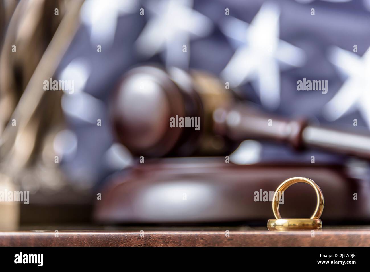 Golden wedding rings with judge gavel, closeup Stock Photo - Alamy