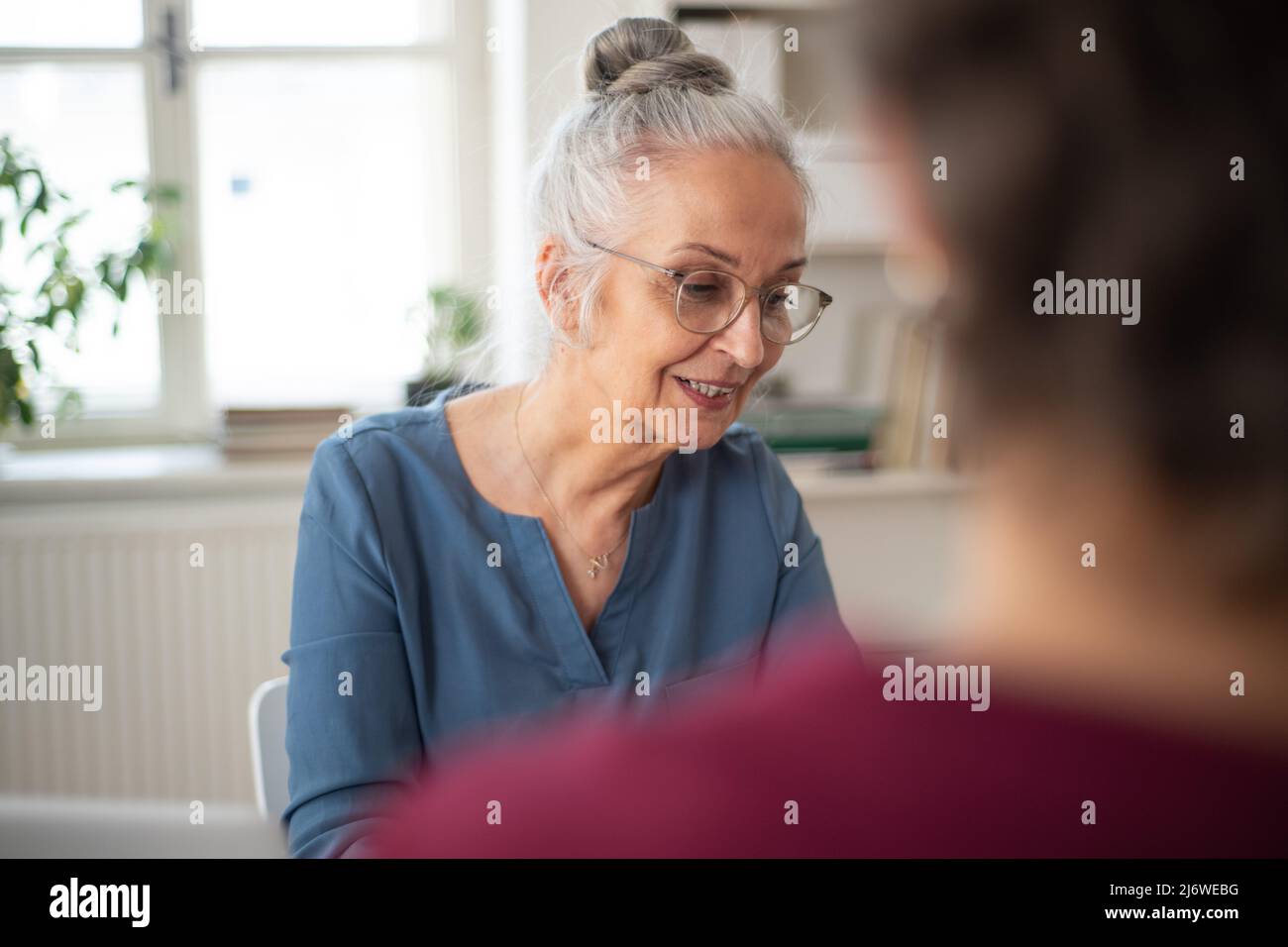 Senior woman recruiter smiling during the job interview Stock Photo - Alamy
