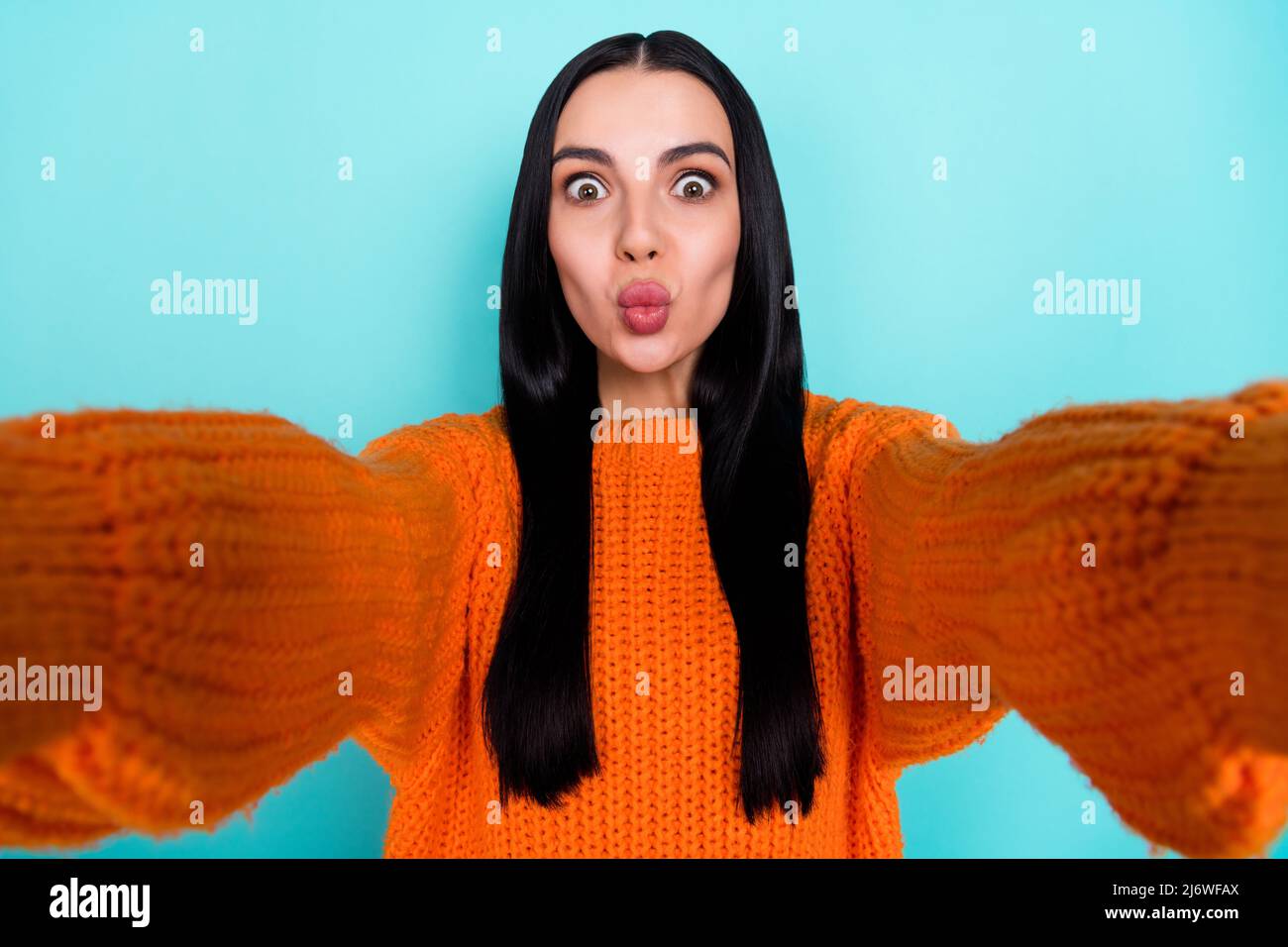 Photo of cute funny woman wear orange sweater tacking selfie sending ...