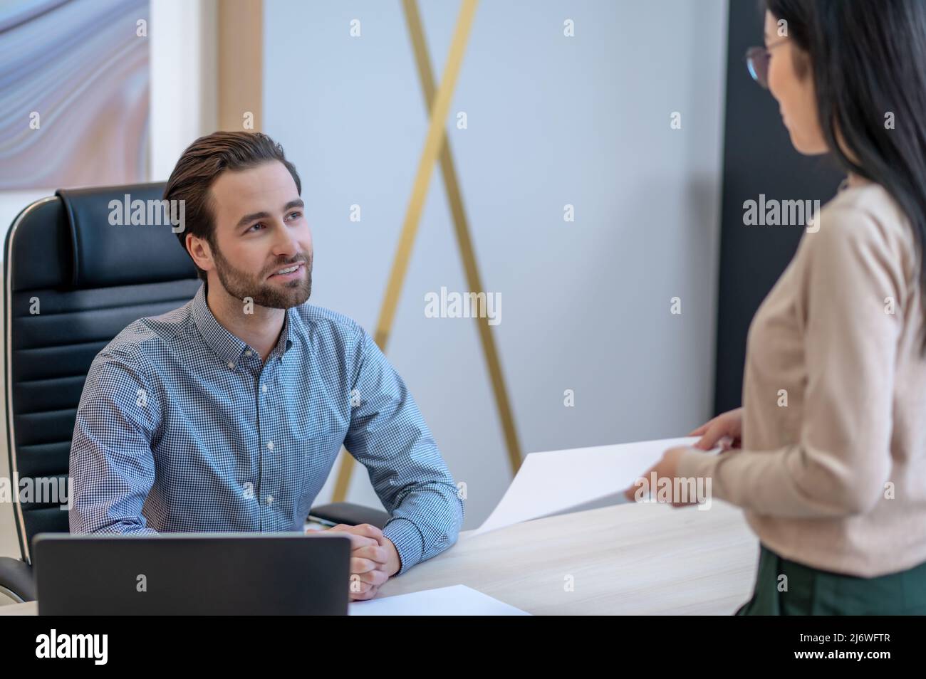 Smiling CEO communicating with the female secretary in his office Stock ...
