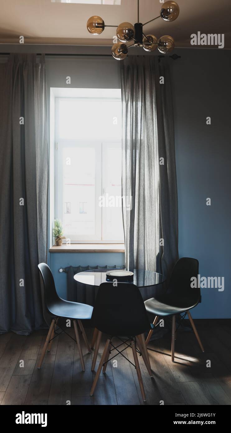 Stylish dining room with modern chairs and table by the window Stock ...