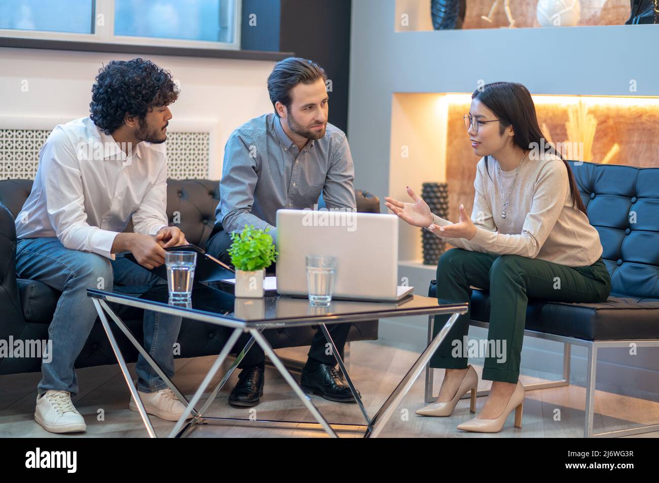 Elegant company director talking to her colleagues Stock Photo - Alamy