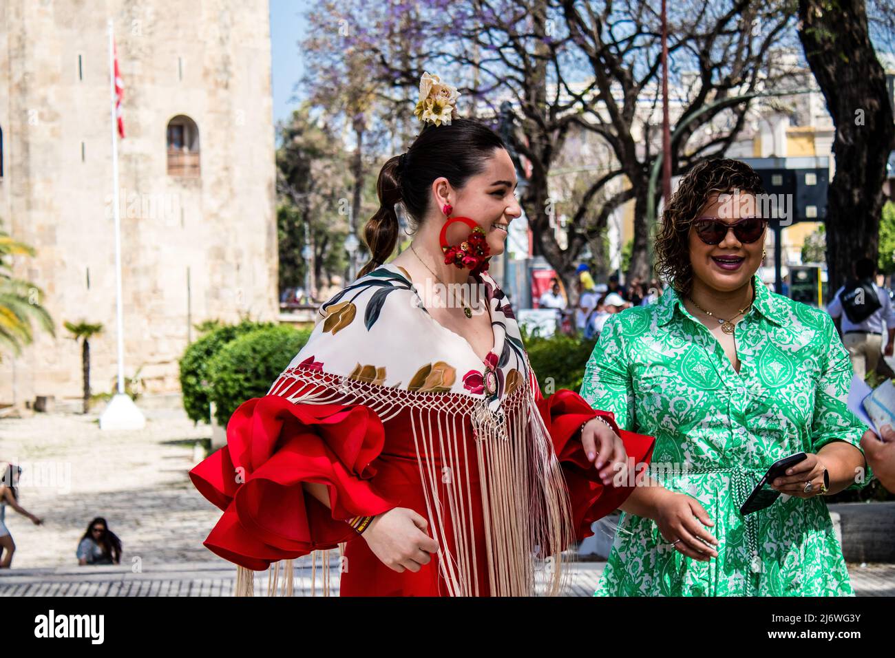 Seville, Spain - May 01, 2022 Sevillians dressed in traditional ...