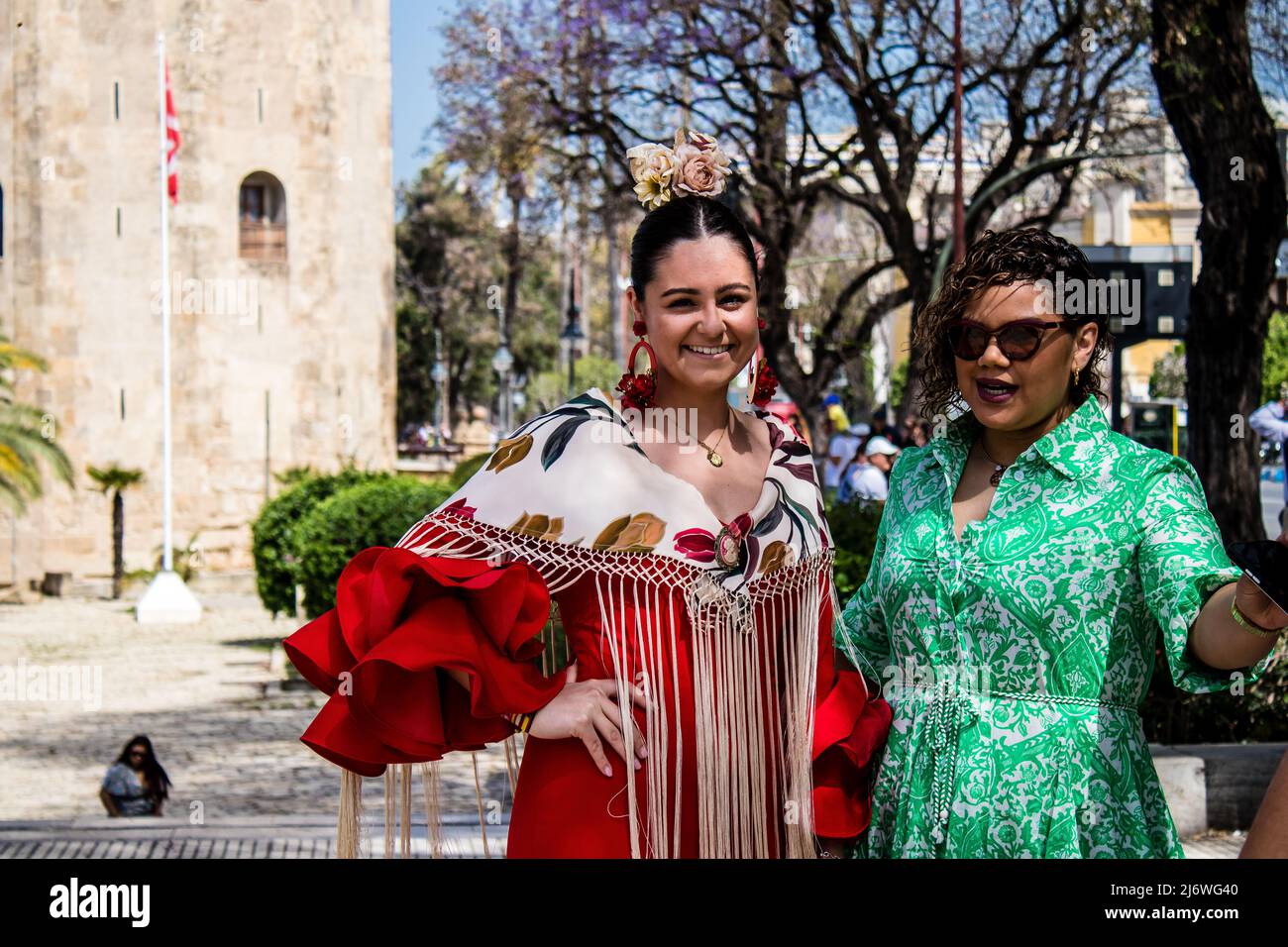 Seville, Spain - May 01, 2022 Sevillians dressed in traditional ...