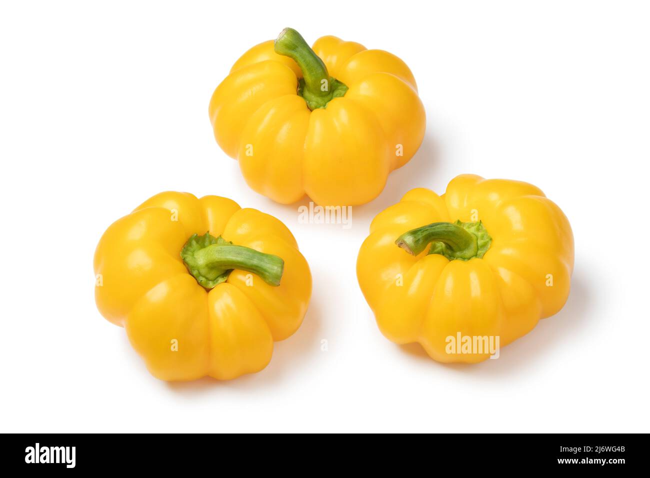 Fresh picked homegrown yellow bell peppers close up isolated on white ...