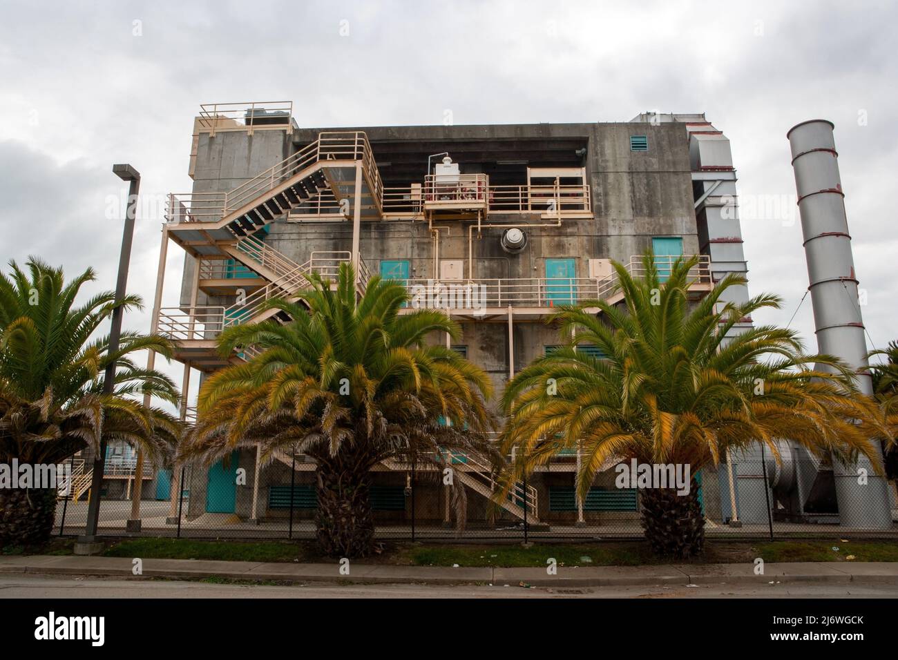 exterior view of a factory with chimney and palm tree Stock Photo - Alamy