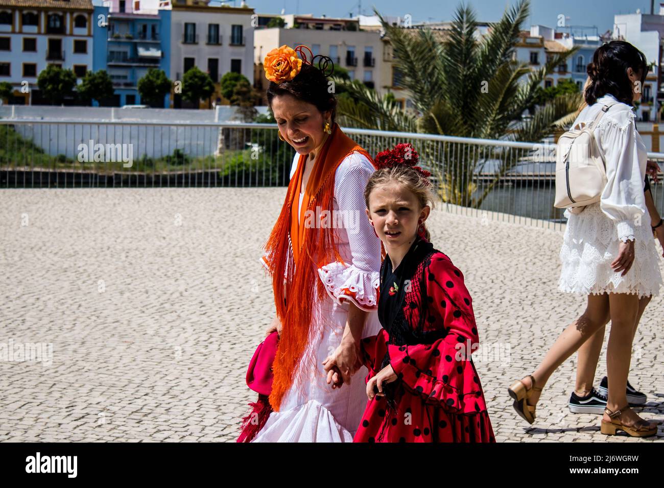 Seville, Spain - May 01, 2022 Sevillians dressed in traditional ...