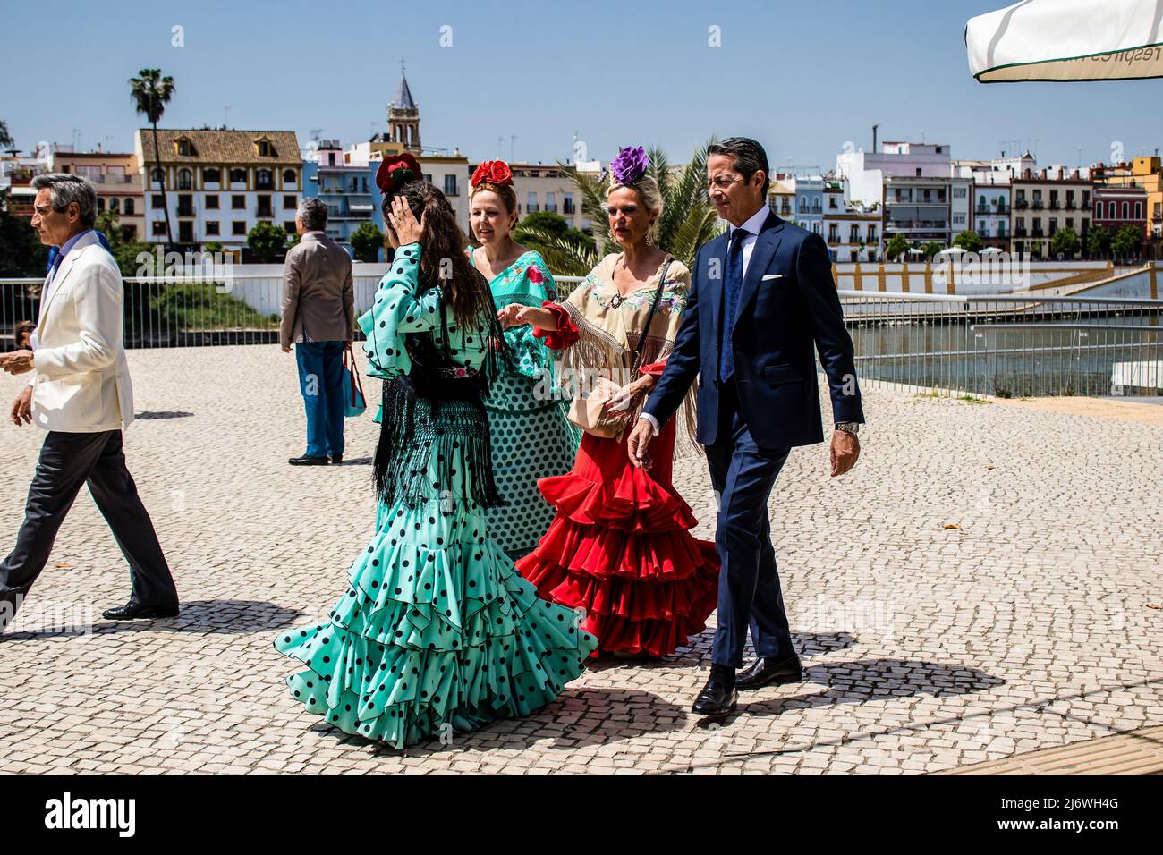 Seville, Spain - May 01, 2022 Sevillians dressed in traditional ...