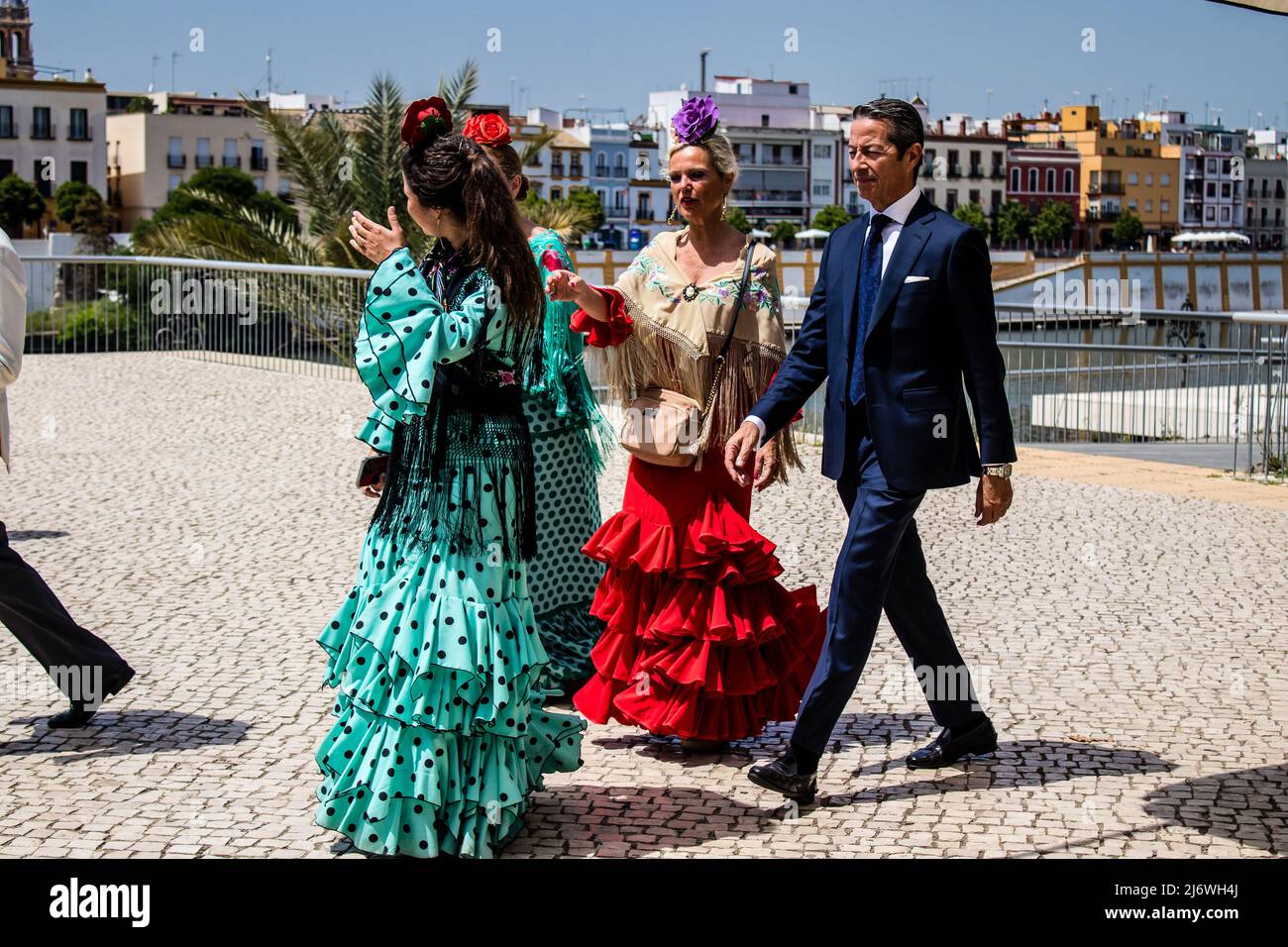 Seville, Spain - May 01, 2022 Sevillians dressed in traditional ...