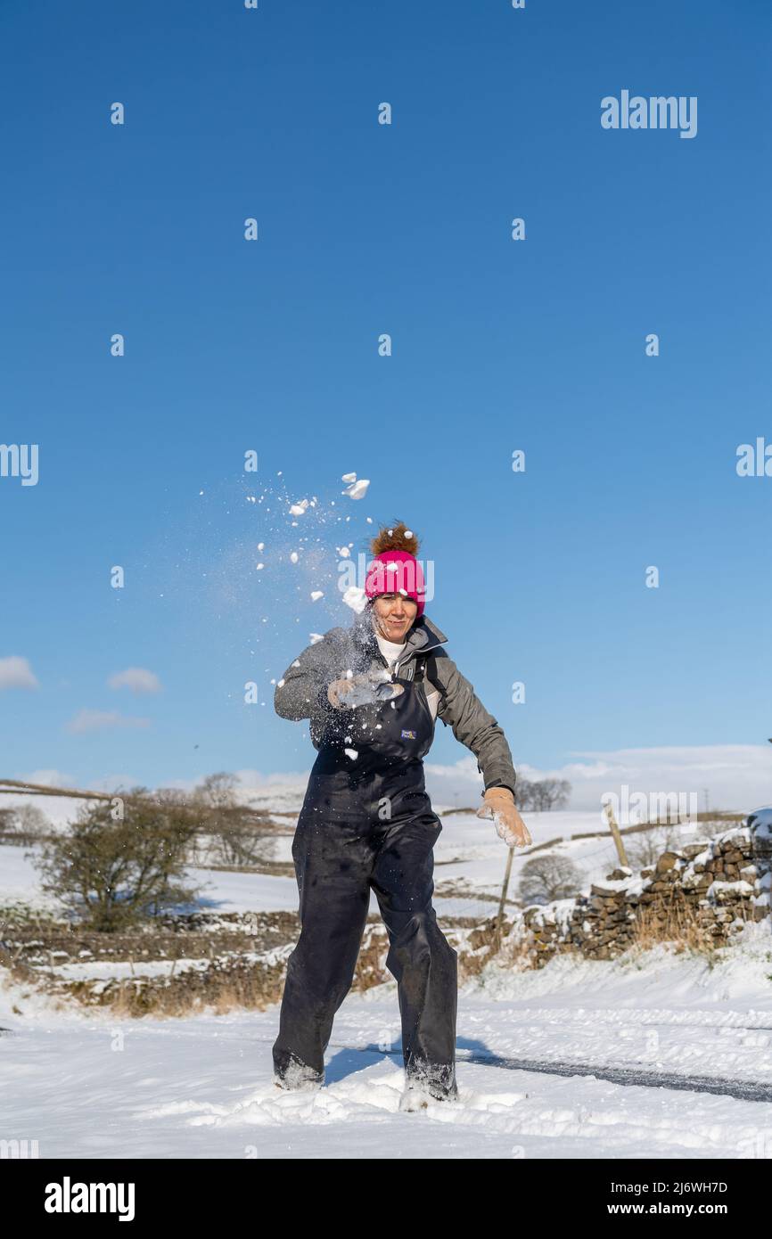 Woman throwing snowball after hi-res stock photography and images - Alamy