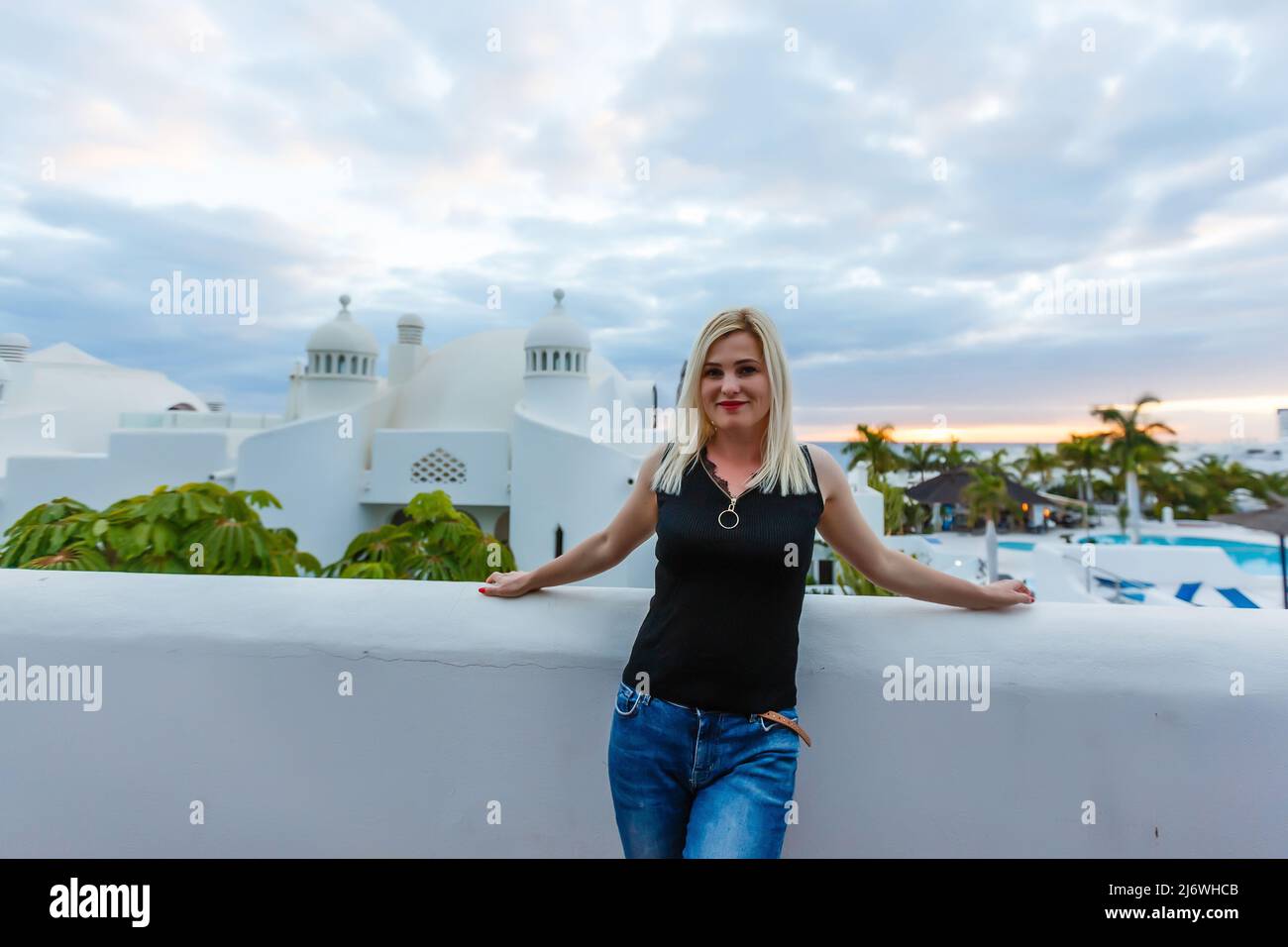 Young girl standing on the balcony overlooking the sea Stock Photo - Alamy
