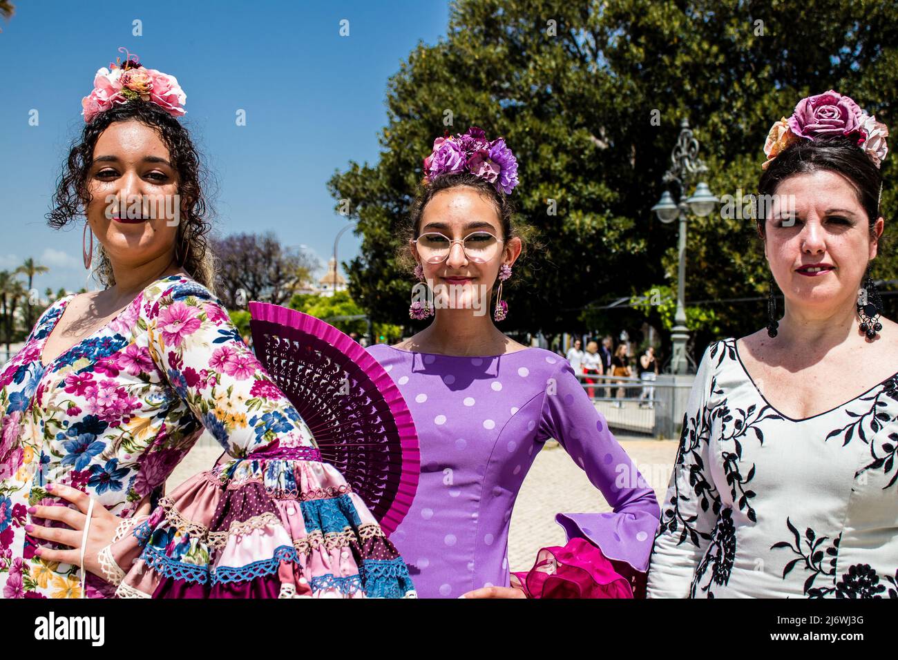 Seville, Spain - May 01, 2022 Sevillians dressed in traditional ...